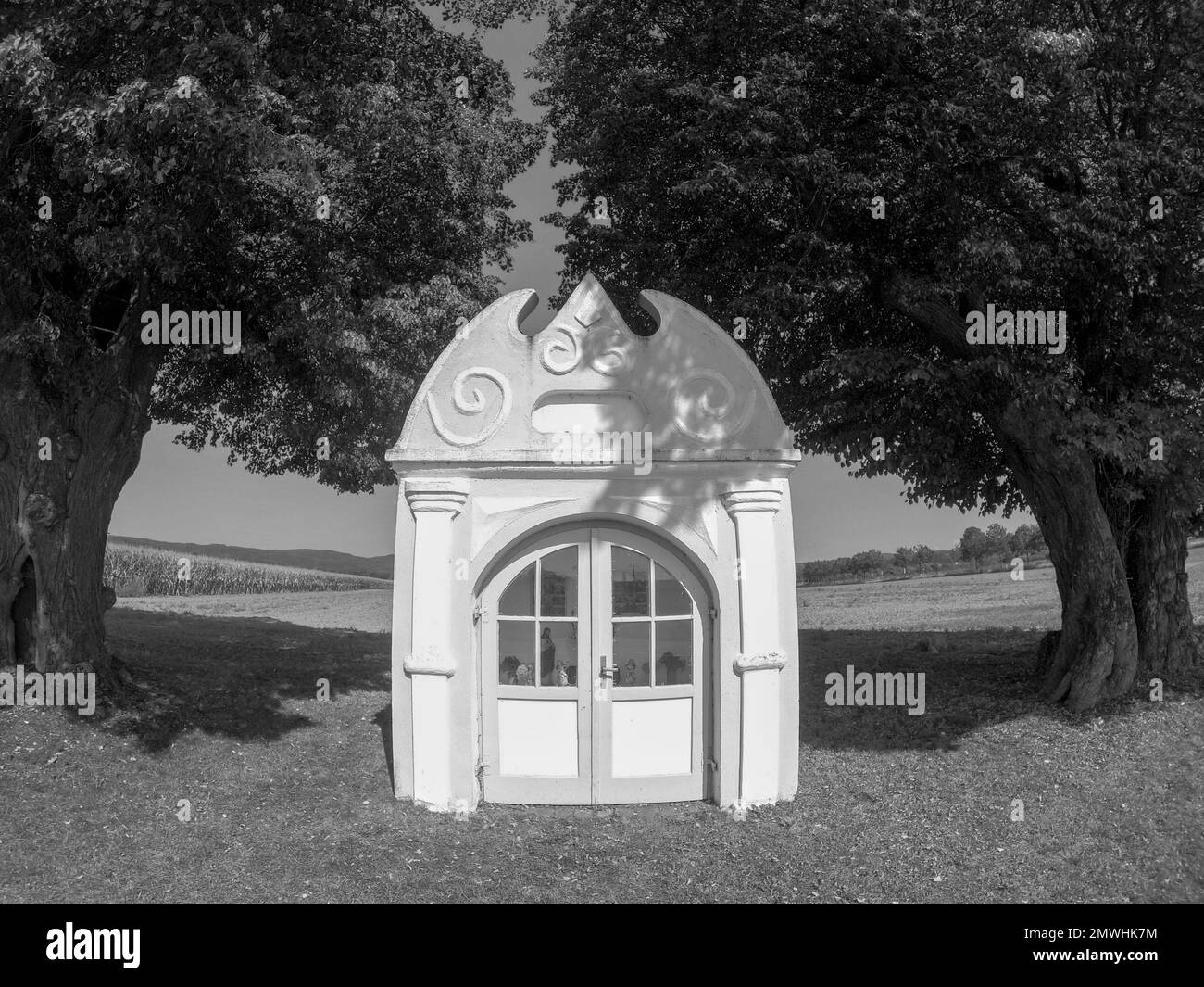 A grayscale of a small house in the field Stock Photo - Alamy