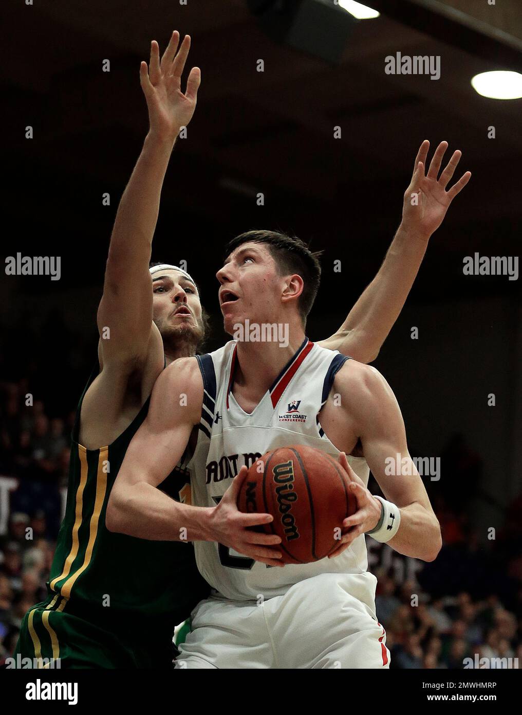 Saint Mary's Dane Pineau, right, looks to shoot against San Francisco's ...