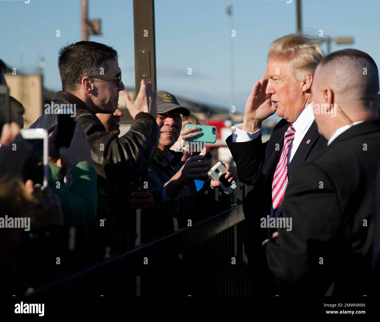 President Donald Trump returns a salute as he greets members of the ...