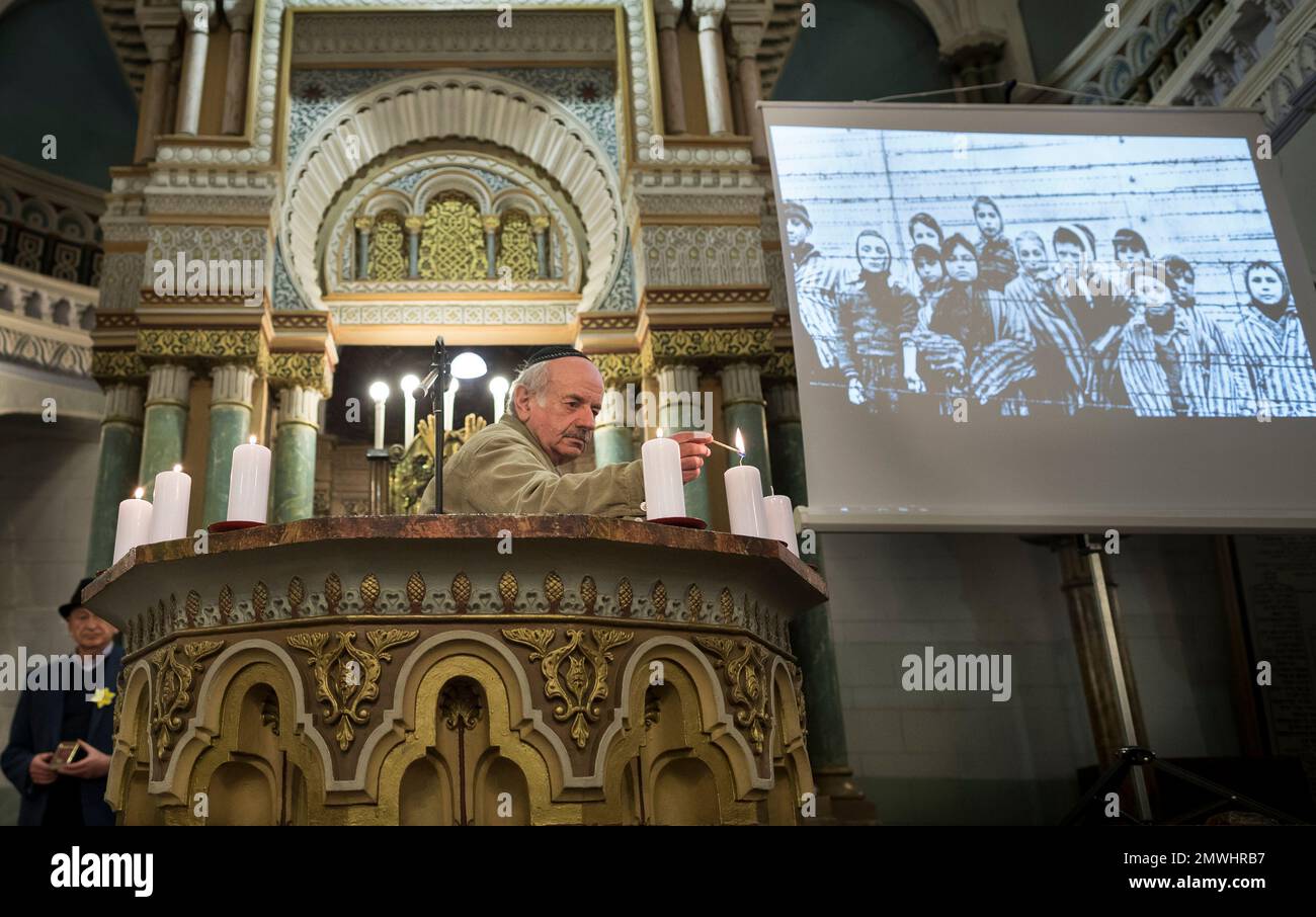 Holocaust survivor Isaak Markus lights a candle during a commemoration ...