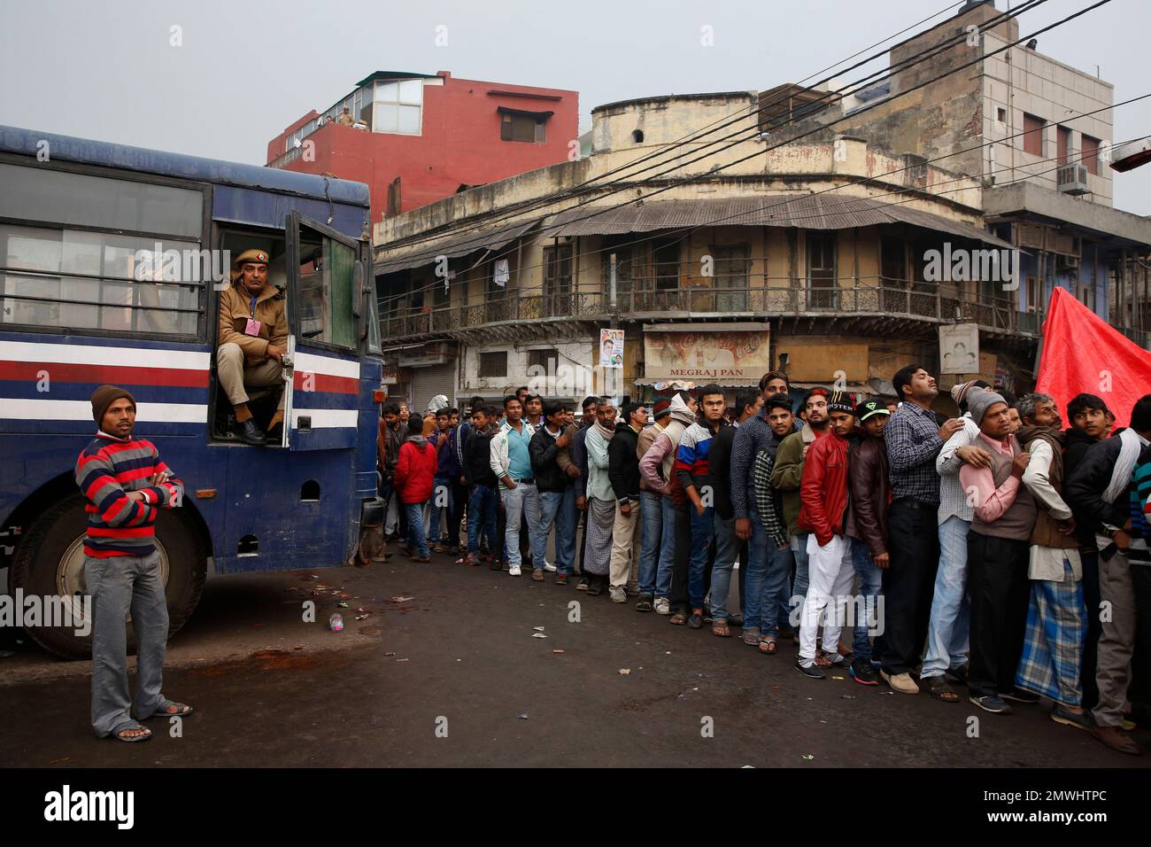 Indians stand in a queue moving towards security gates to enter the ...