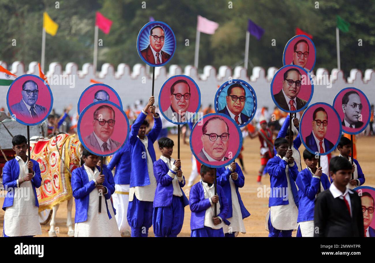School children hold portraits of Bhim Rao Ambedkar as they perform ...
