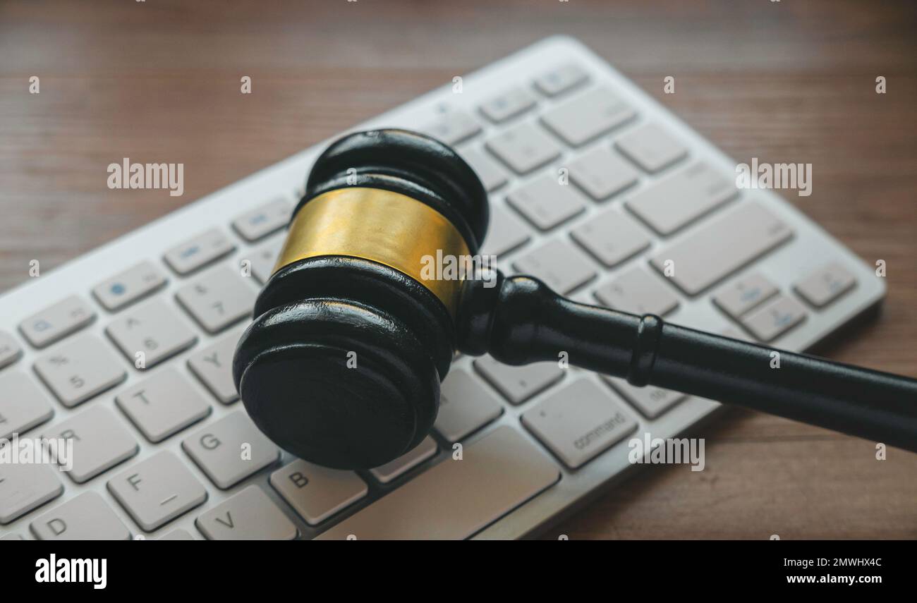 Concept of internet crime with gavel, computer keyboard and mouse on a wooden background Stock ...