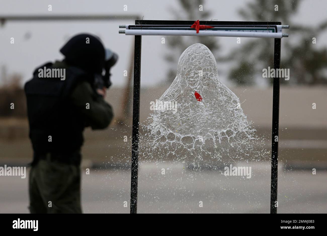 Palestinians shoot a water balloon with a paint gun during a training ...