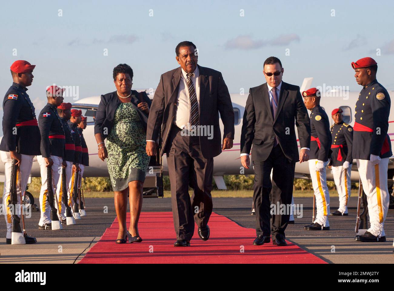 Dominica's President Charles Savarin, center, walks alongside his wife ...