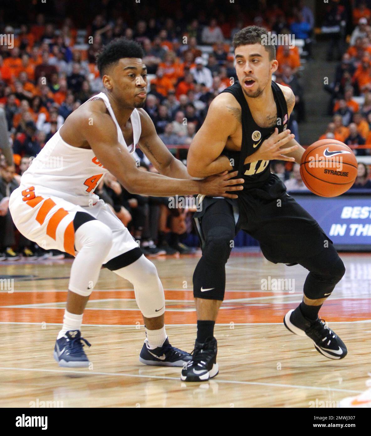 Wake Forest's Mitchell Wilbekin, right, tries to dribble past Syracuse ...