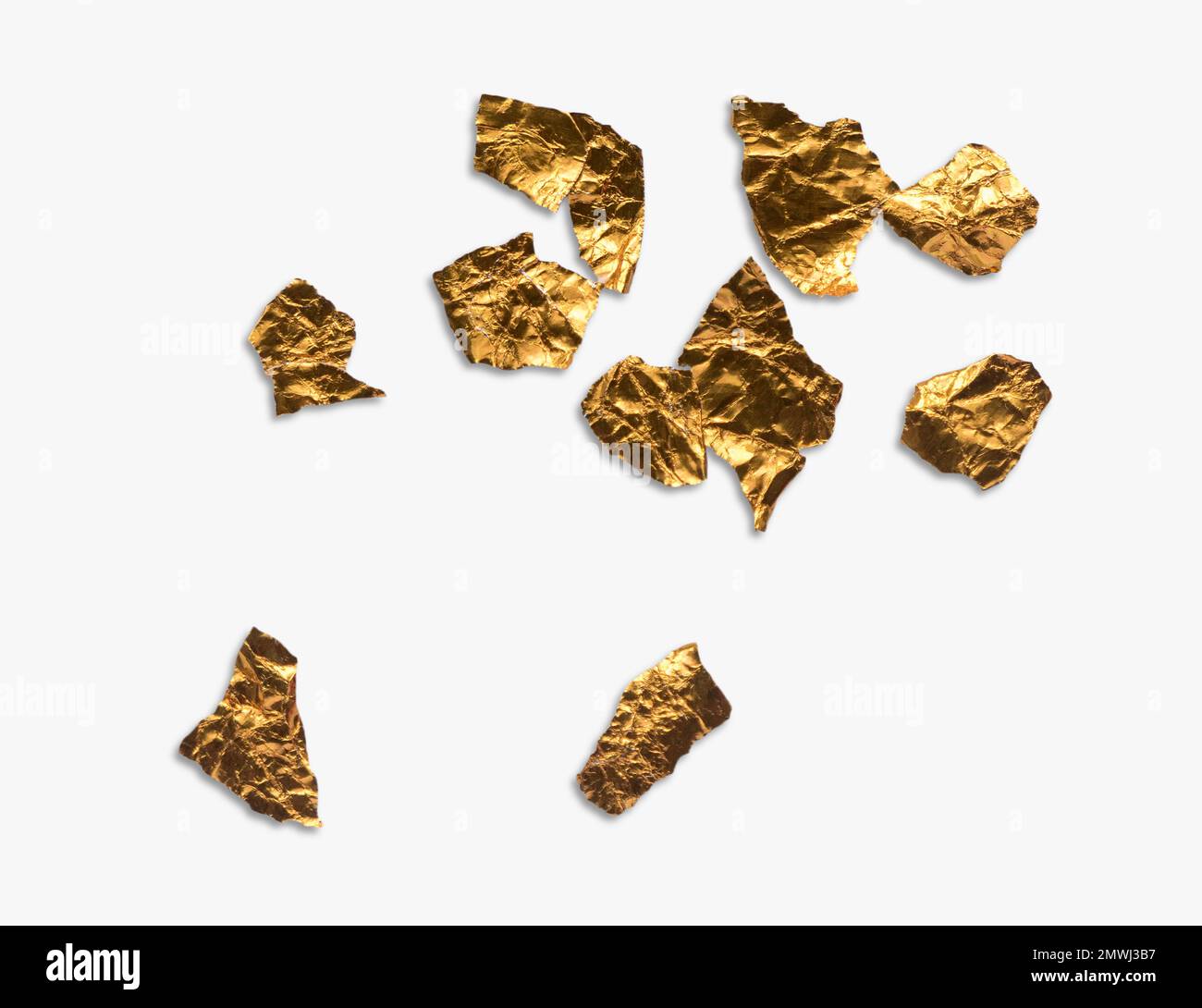 Shiny pieces of crumpled and creased gold foil or leaf isolated on a ...
