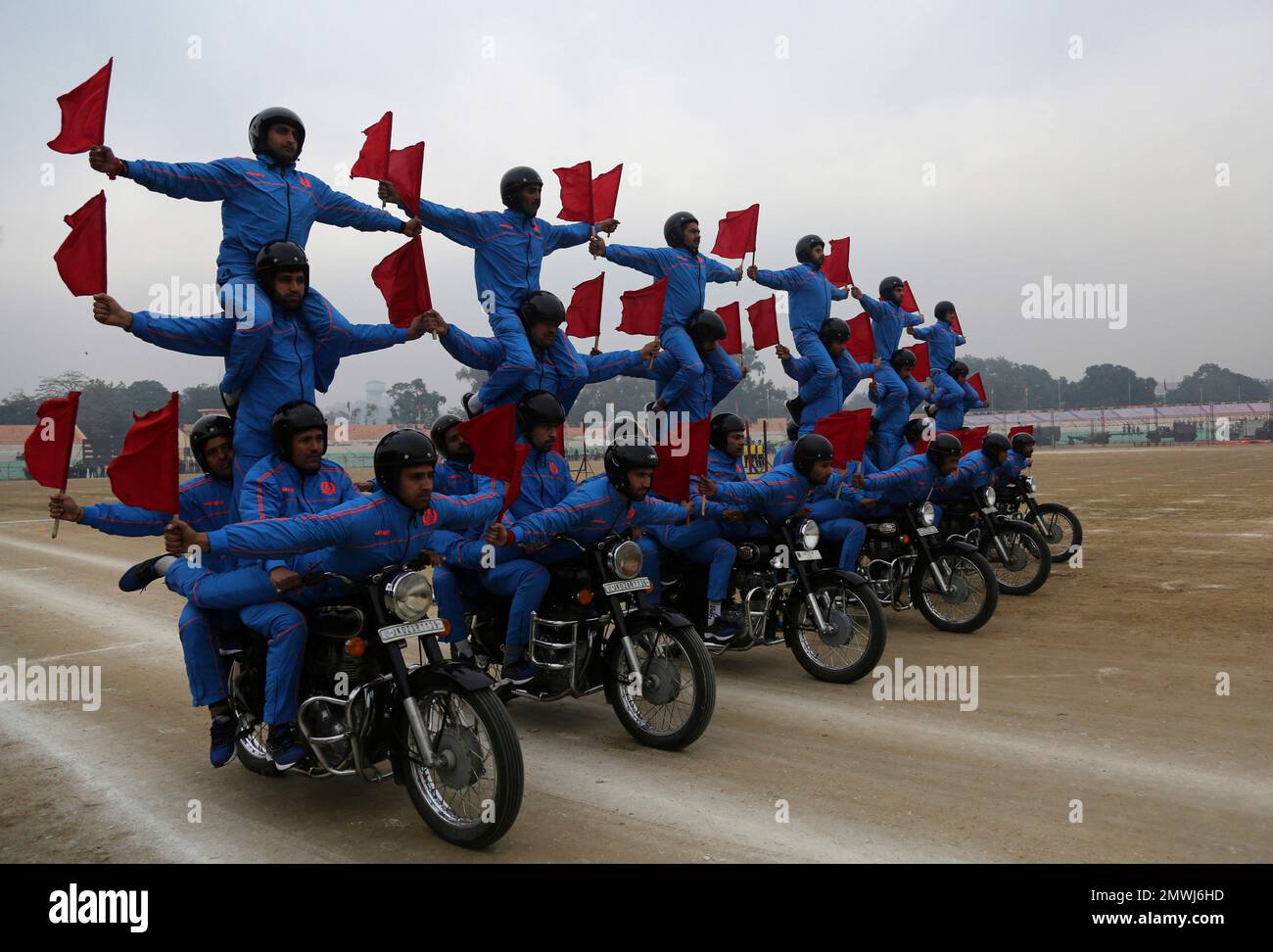 Indian policemen perform acrobatic skills on a motorcycle during ...