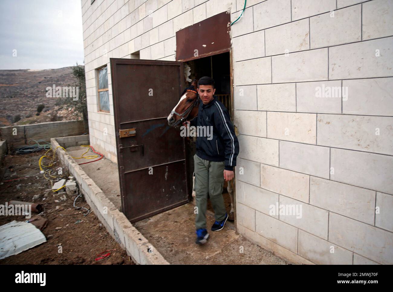 In this Thursday, Jan. 5, 2017 photo, Palestinian Hamza Hamad,16, walks ...