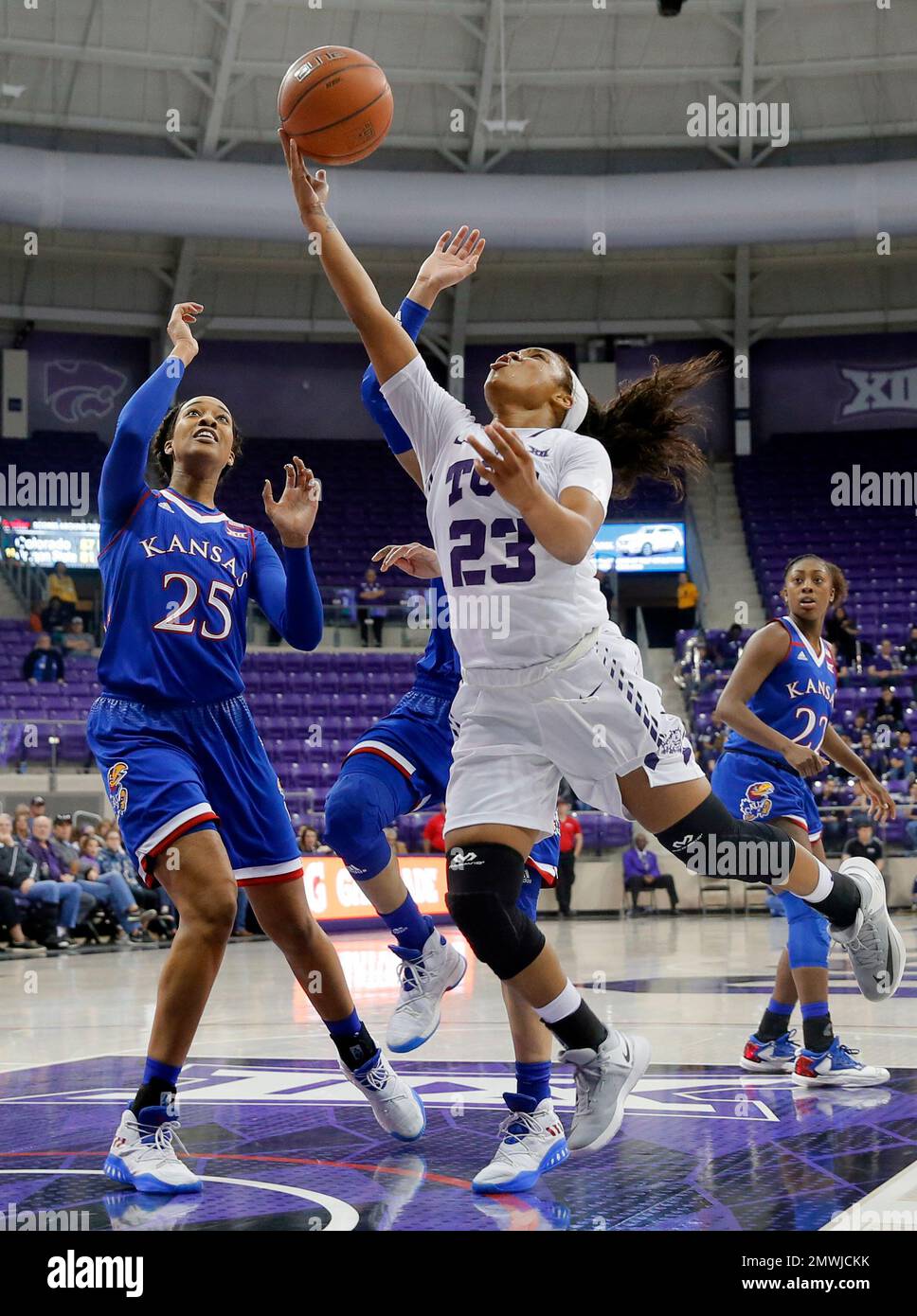 Kansas' Caelynn Manning-Allen (25) defends as TCU's AJ Alix (23) goes ...