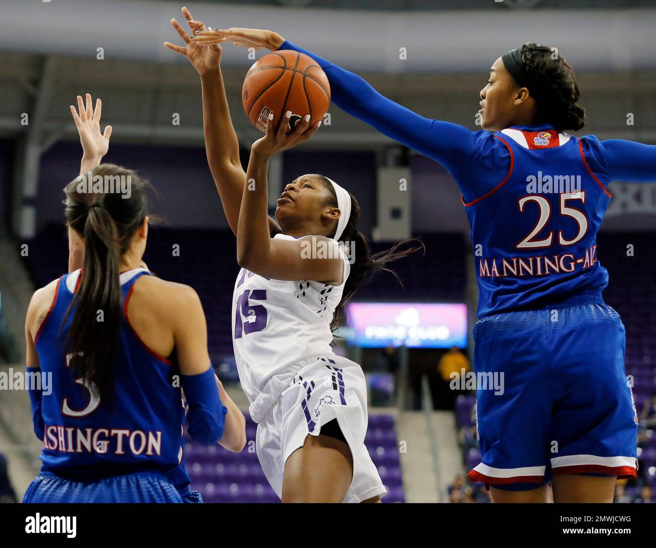 TCU forward Jada Butts (15) goes up for a shot as Kansas' Jessica ...