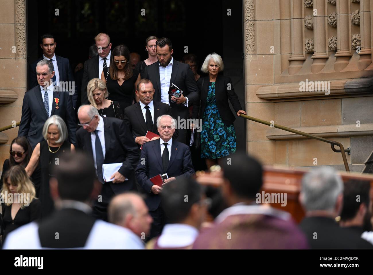 Former Prime Minister Tony Abbott (centre) looks on as the casket of ...