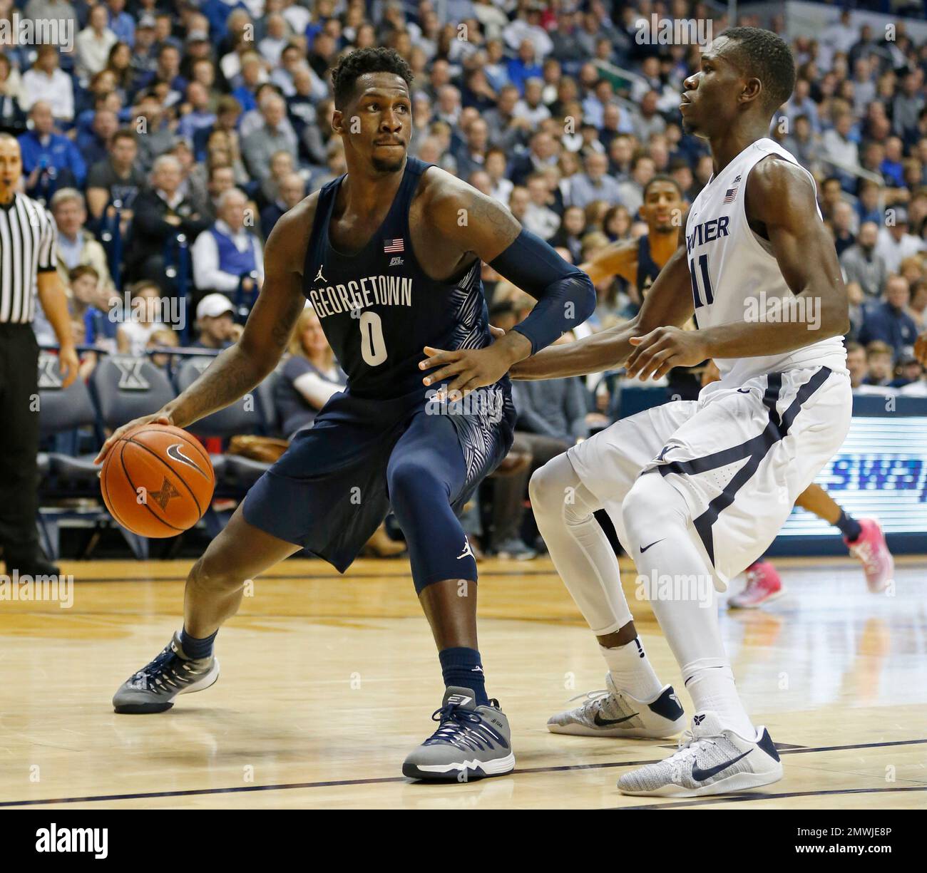Georgetown guard L.J. Peak (0) drives to the basket against Xavier ...