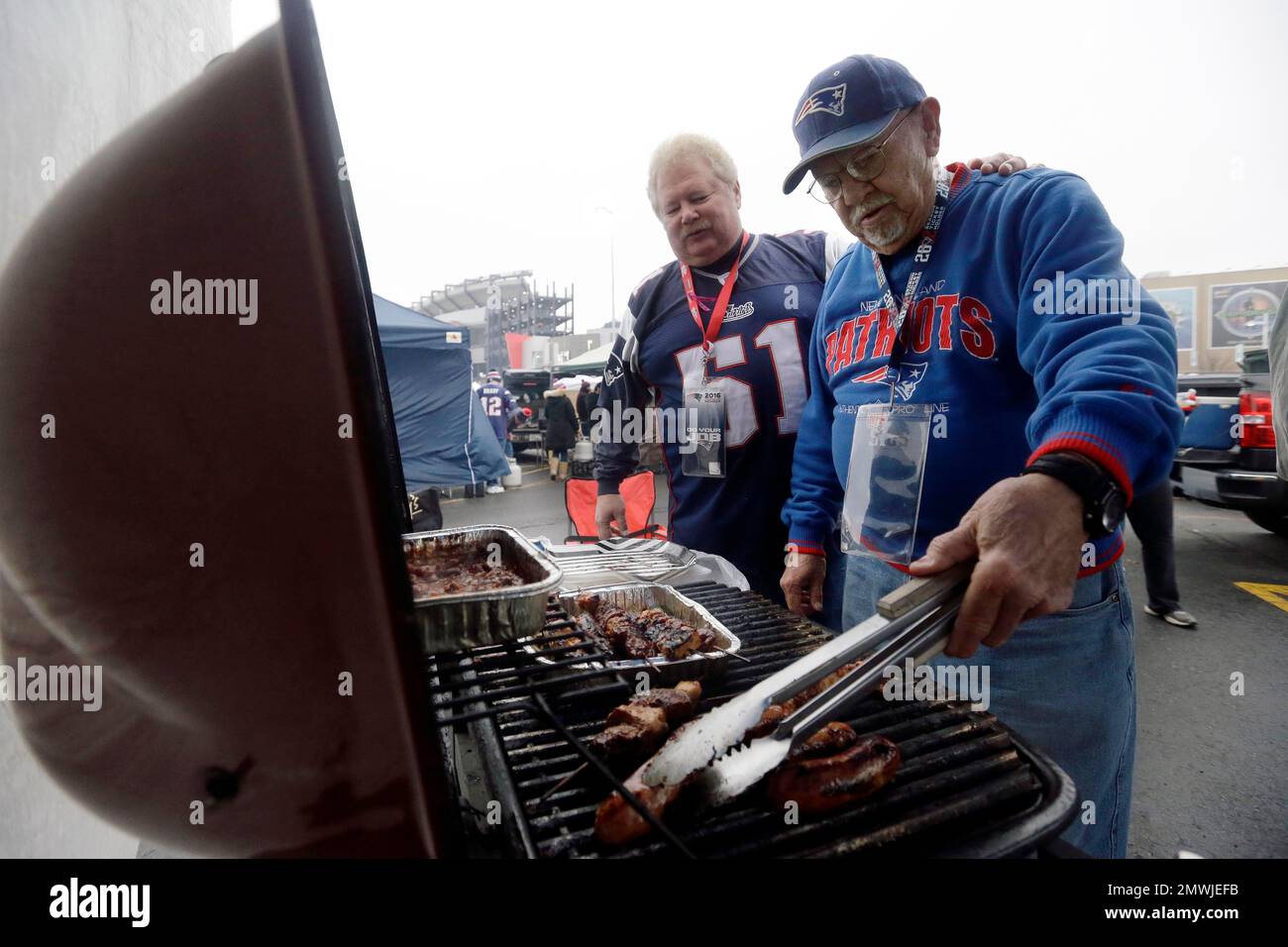 John Skaibinski, right, tends the grill while tailgating with his son ...