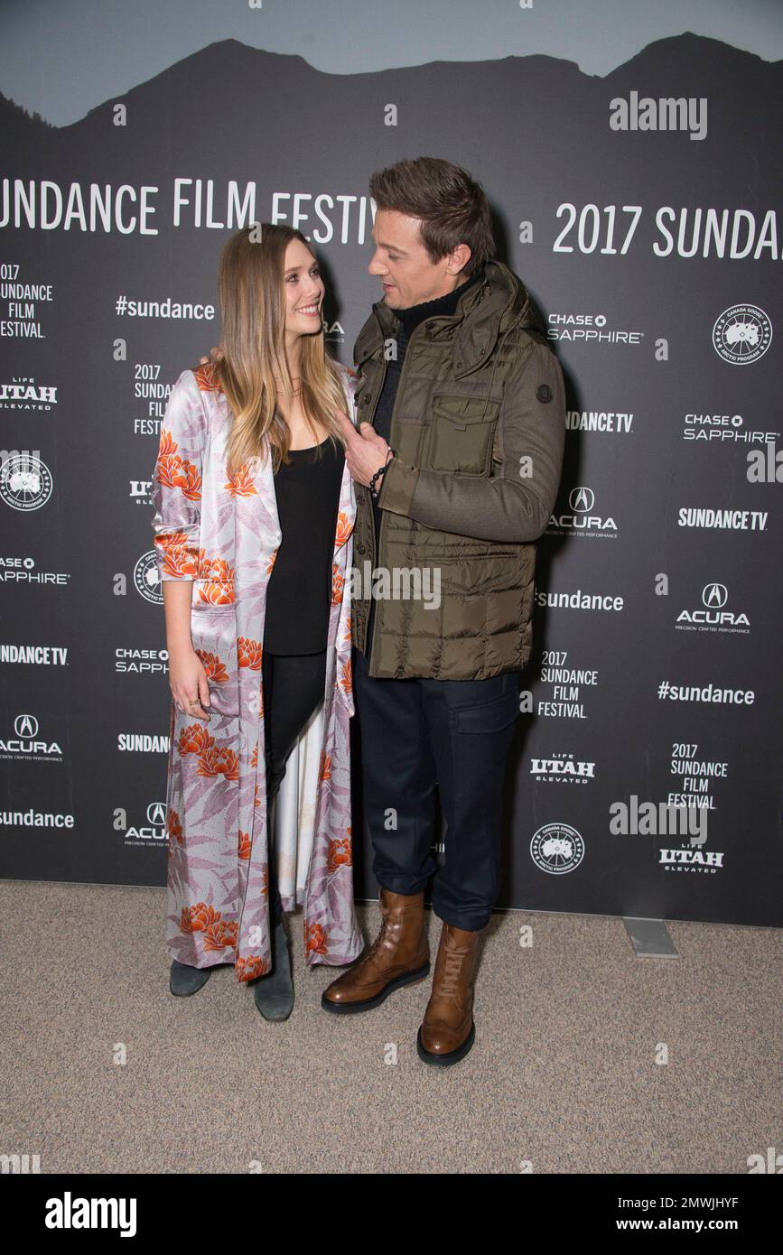 Actors Elizabeth Olsen, left, and Jeremy Renner pose at the premiere of ...