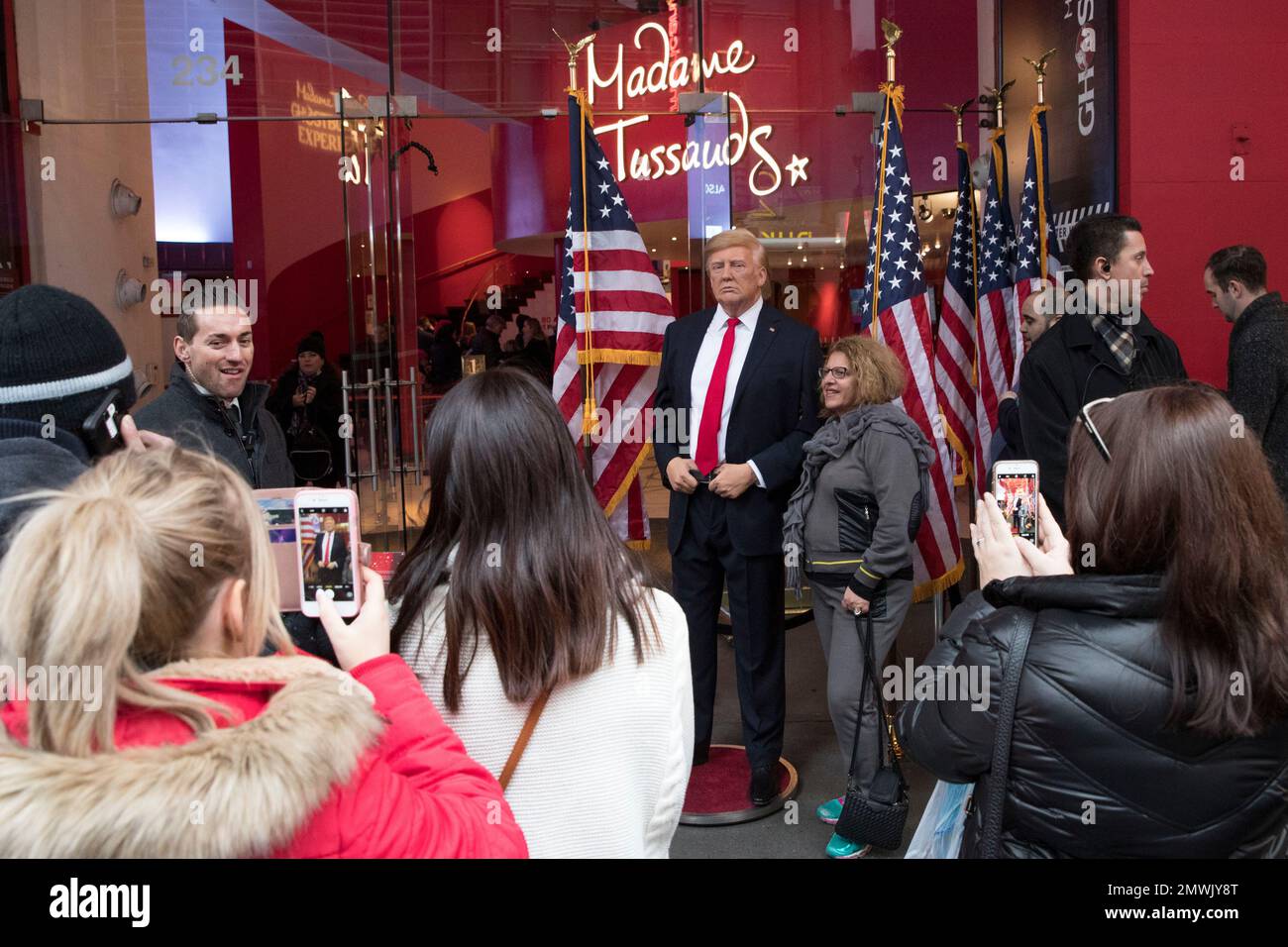 Visitors to New York's Times Square stop to take photos of a wax figure ...