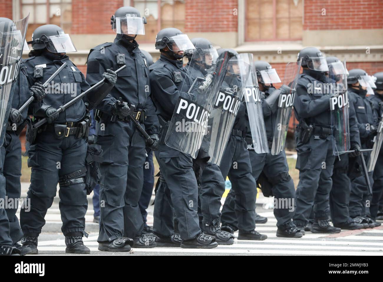 Riot officers form a line to split a group of protestors during a ...