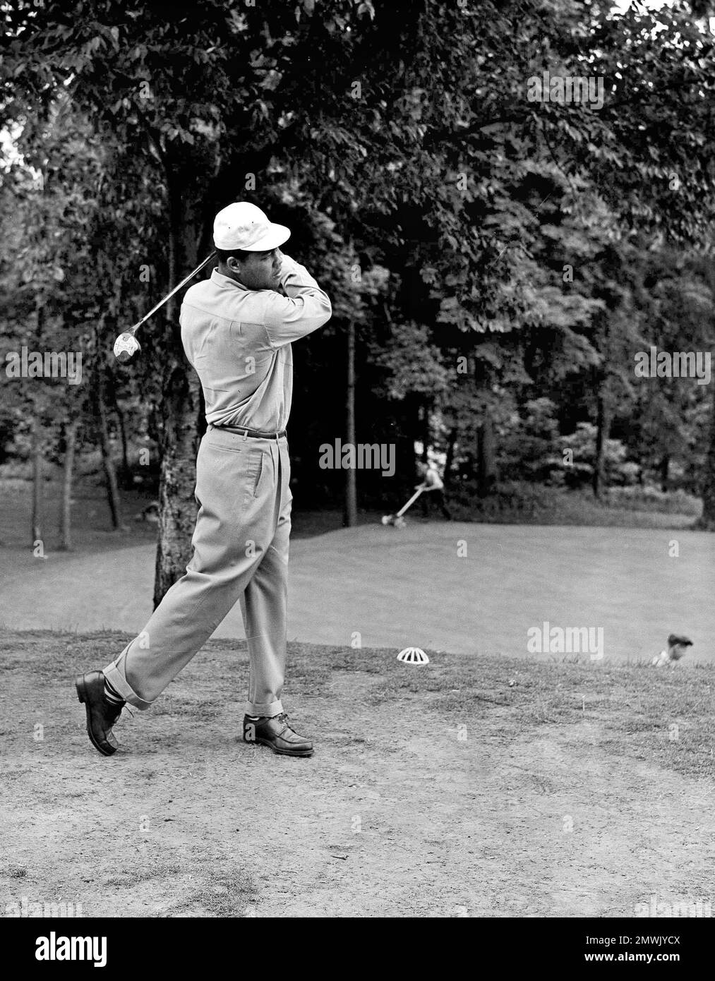 Another sock taken as Joe Louis hits the pill teeing off during his ...