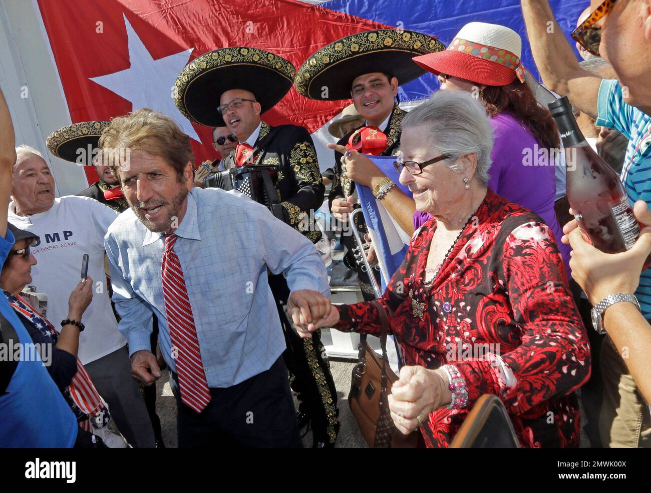 Cuban-American Miguel Saavedra, left, dances to the music of a mariachi ...