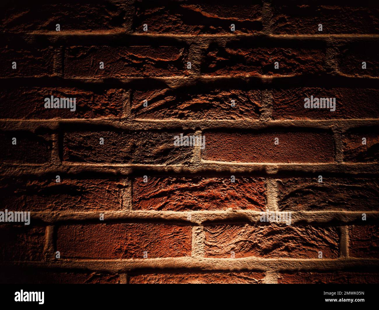 A closeup of a red brick wall with dim lighting - great for backgrounds ...