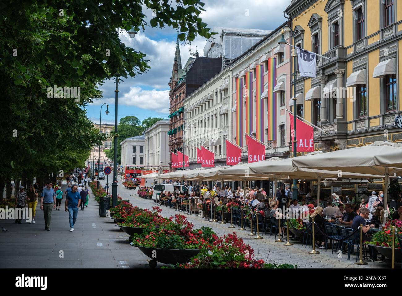 A famous street in Oslo with modern buildings and an open-air cafe on a ...