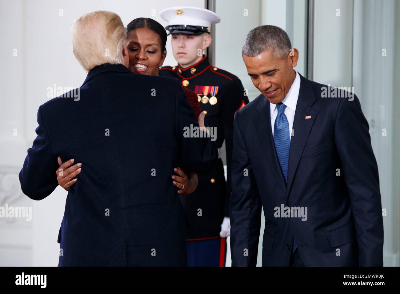 President Barack Obama stands at right as first lady Michelle Obama ...