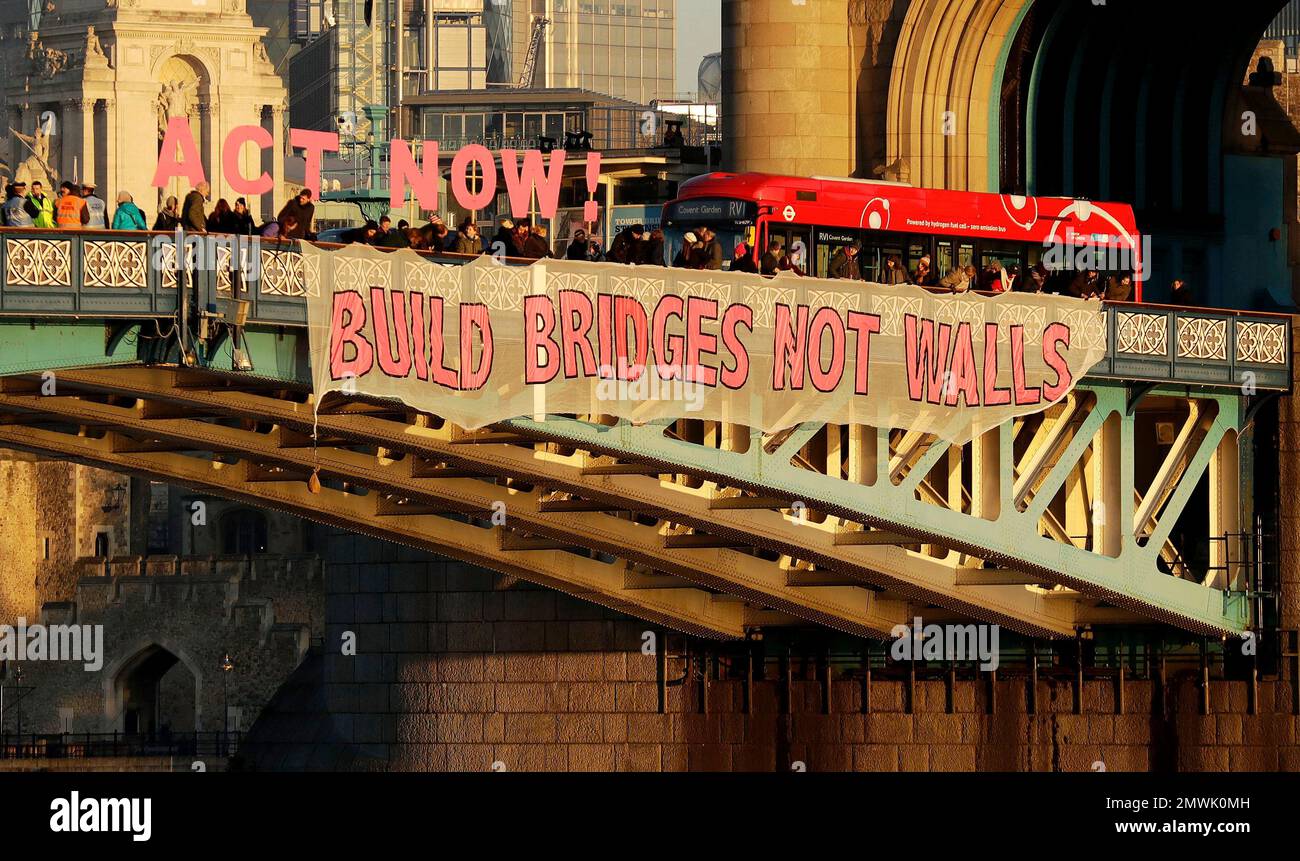 Campaigners hold a banner reading "Build Bridges Not Walls" from Tower ...