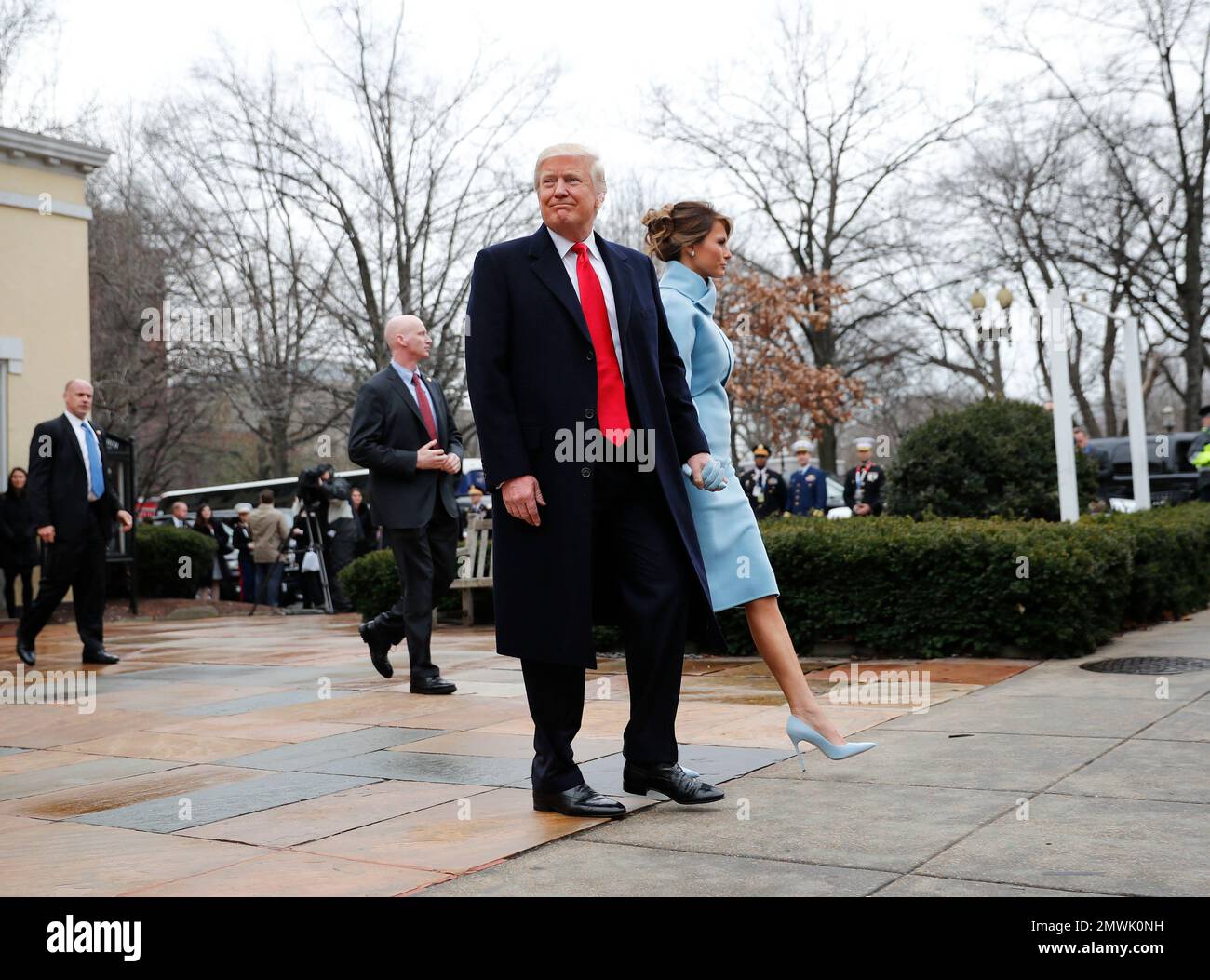 President-elect Donald Trump and his wife Melania walk to their vehicle ...