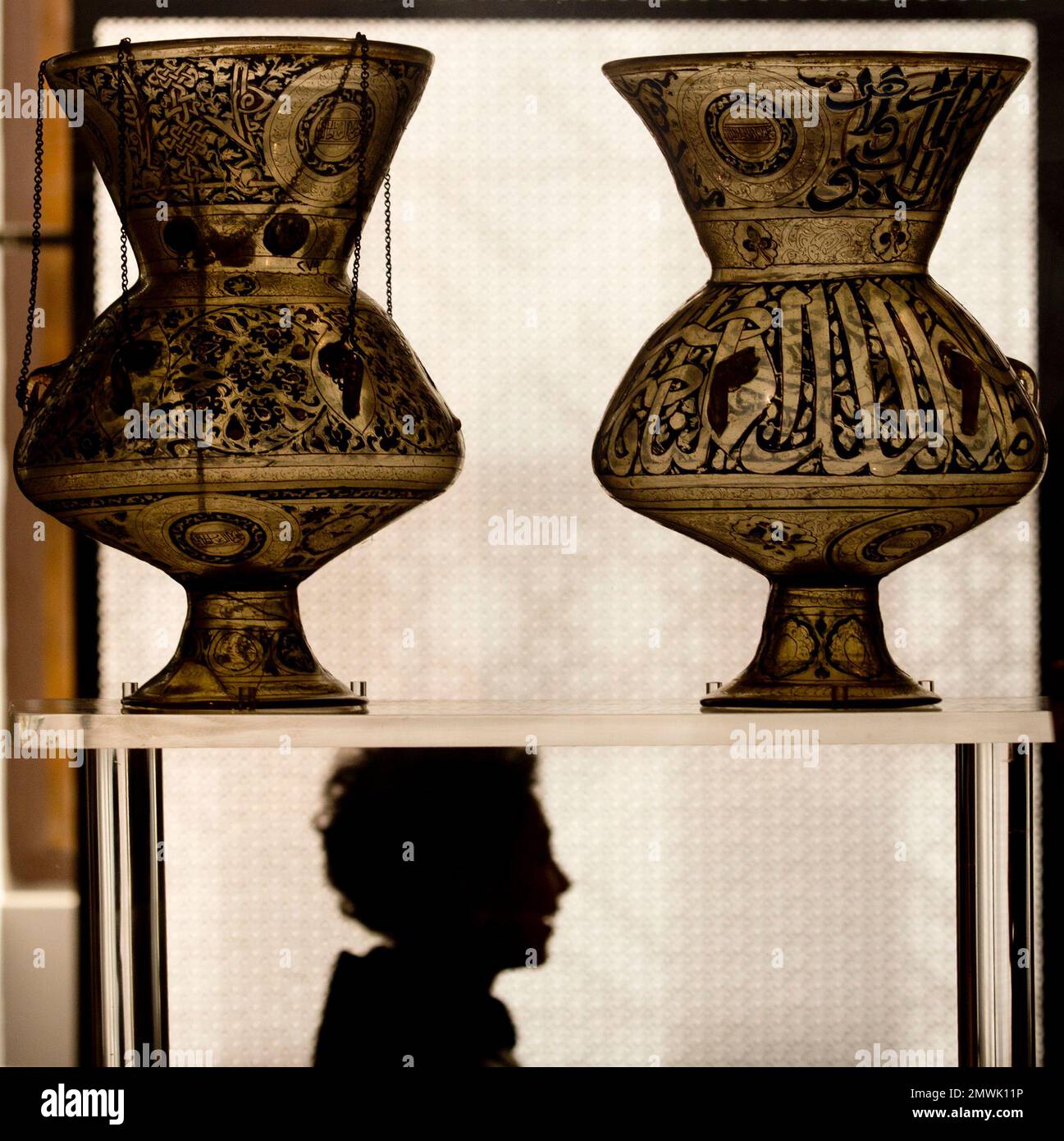 A visitor walks past an ancient mosque lamps dated to Mamluk period ...