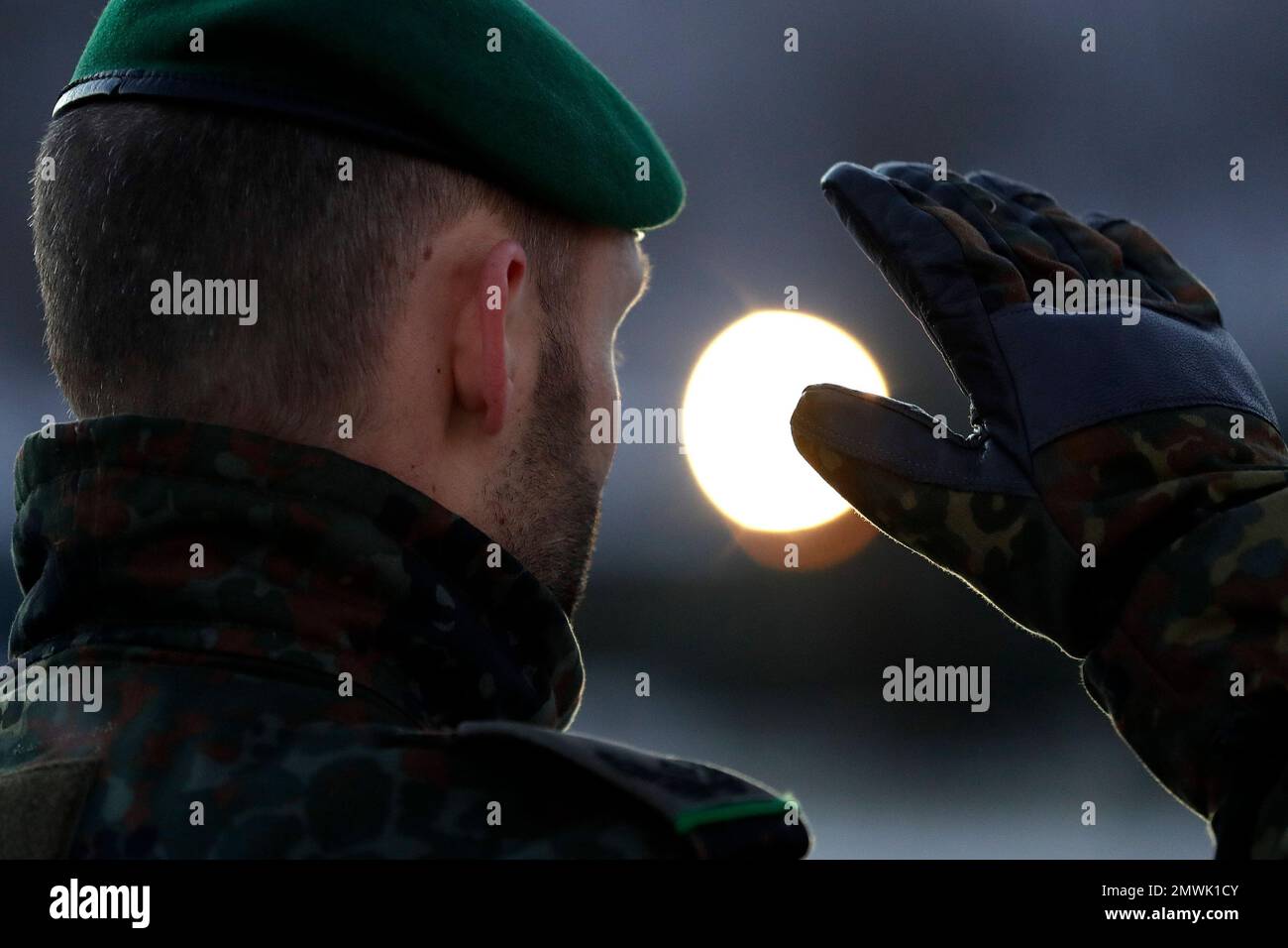A German Bundeswehr soldier of the 122th Infantry Battalion salutes as ...