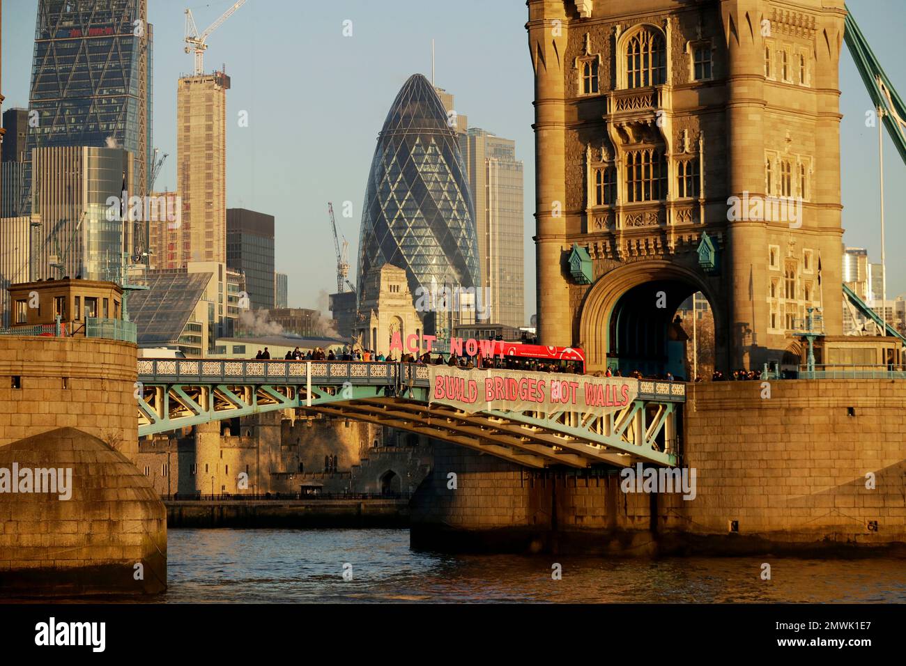 Campaigners hold a banner reading "Build Bridges Not Walls" from Tower ...