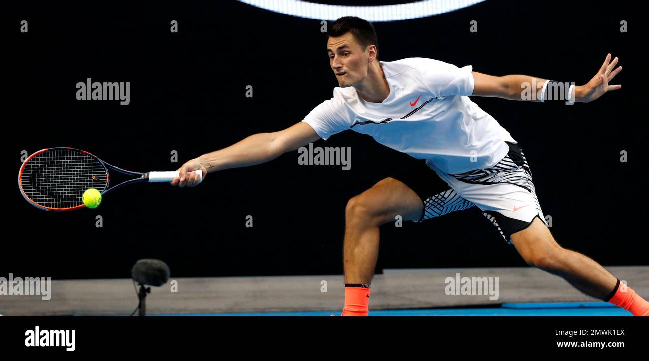 Australia's Bernard Tomic reaches for a return to Britain's Daniel ...