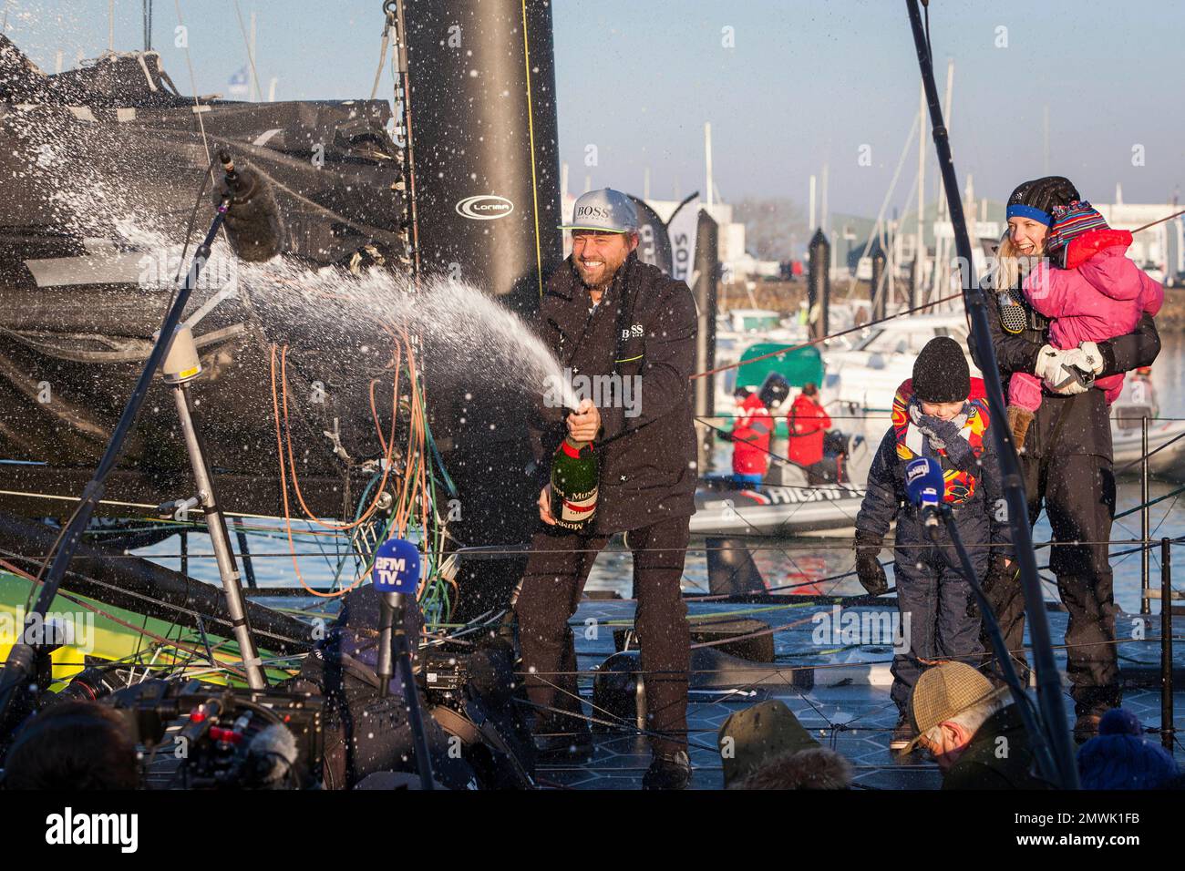 British skipper Alex Thomson sprays Champagne with his wife Kate, right ...