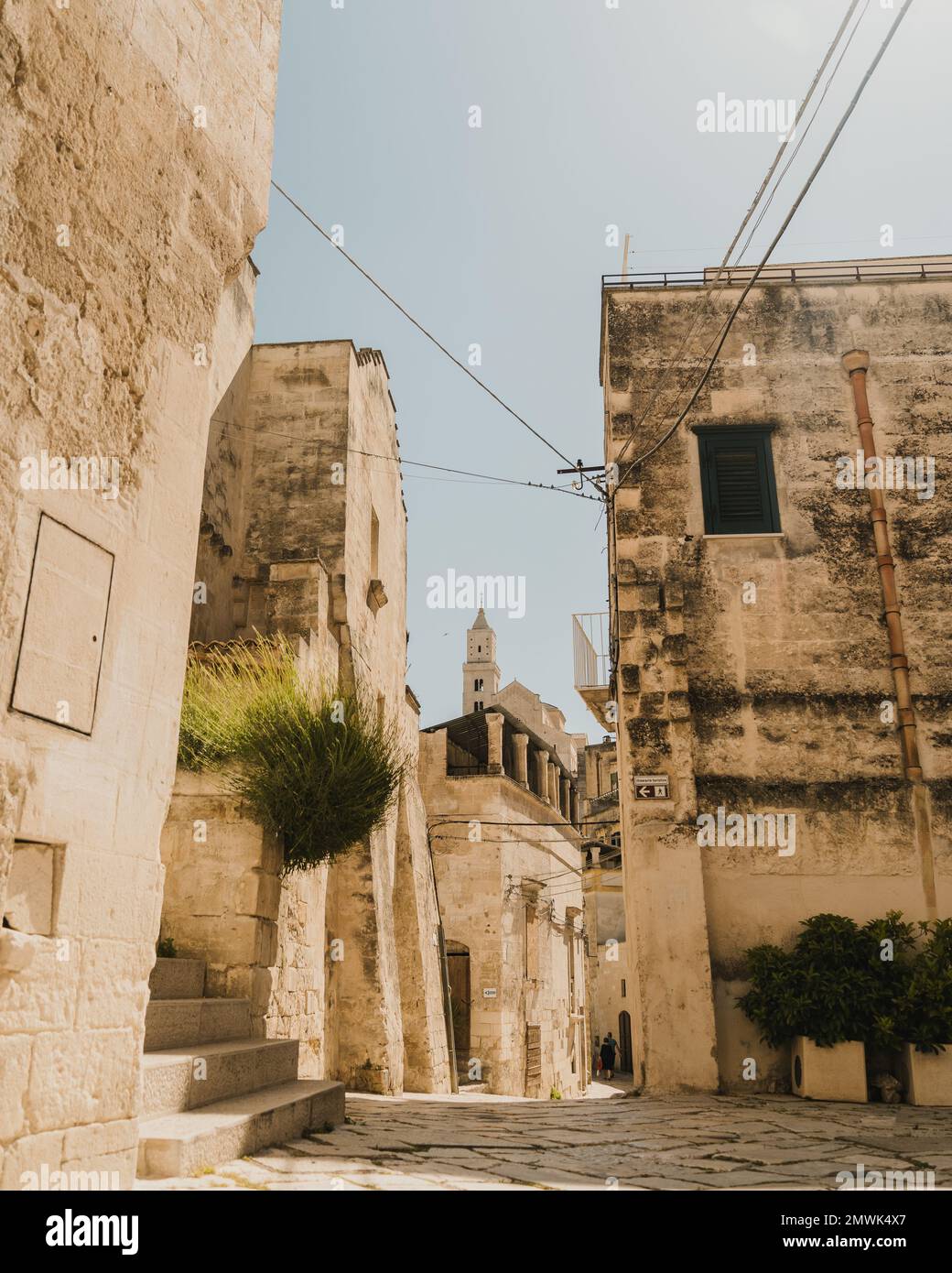 A vertical shot of the Cathedral of San Sabino seen between buildings ...