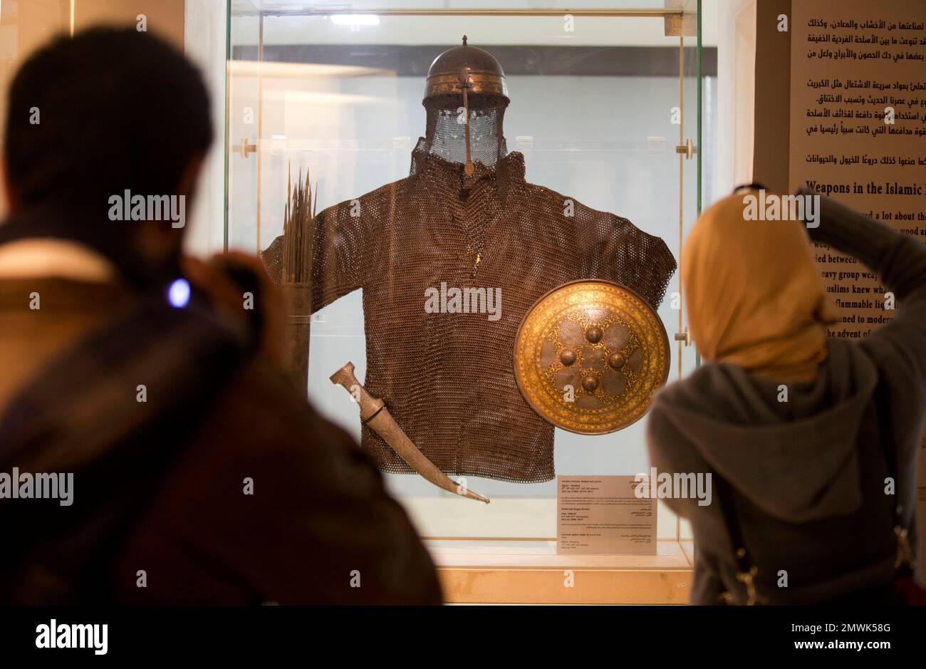 Visitors take picture of a warrior costume, helmet and quiver dated to ...