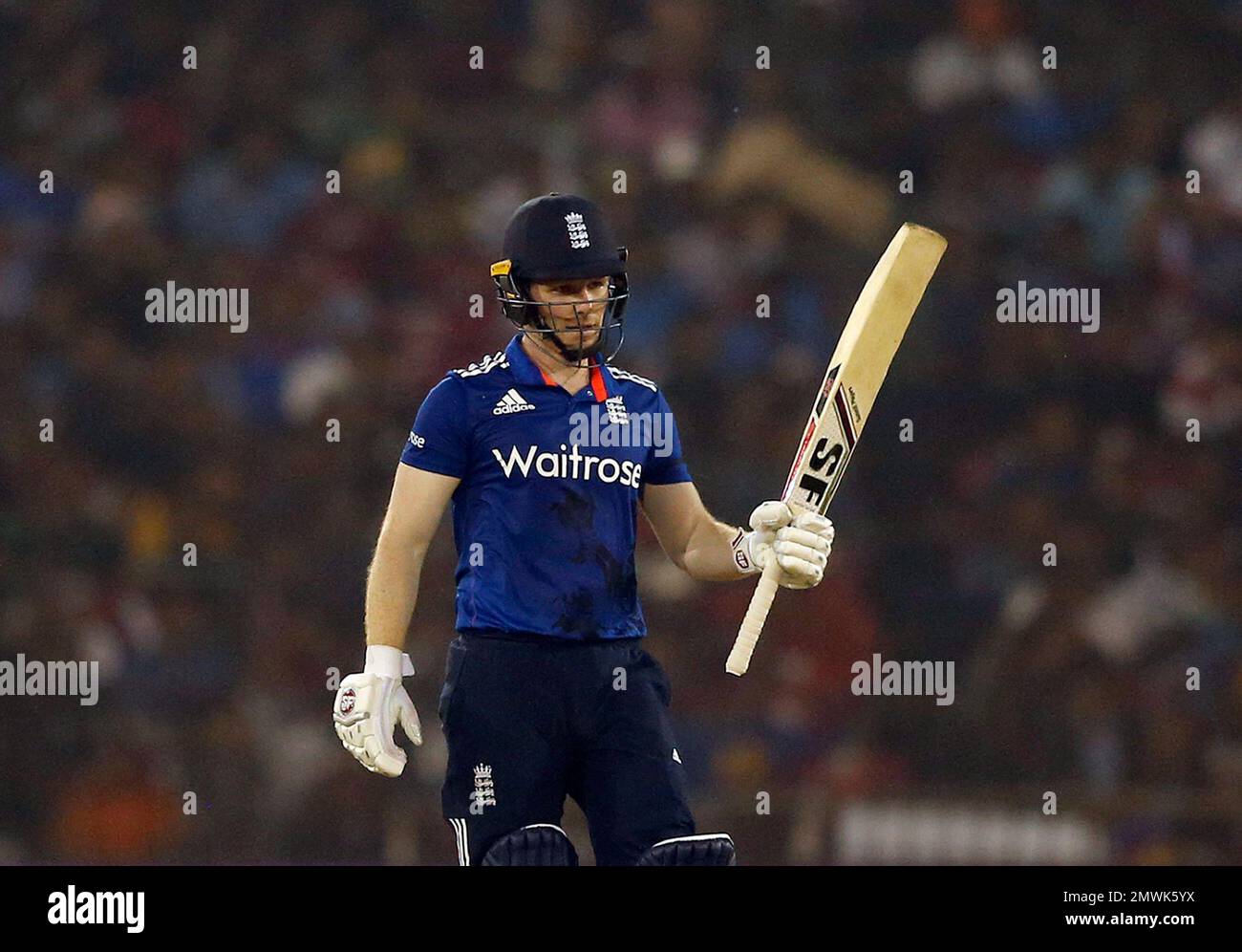 England's captain Eoin Morgan raises his bat to celebrate scoring fifty ...