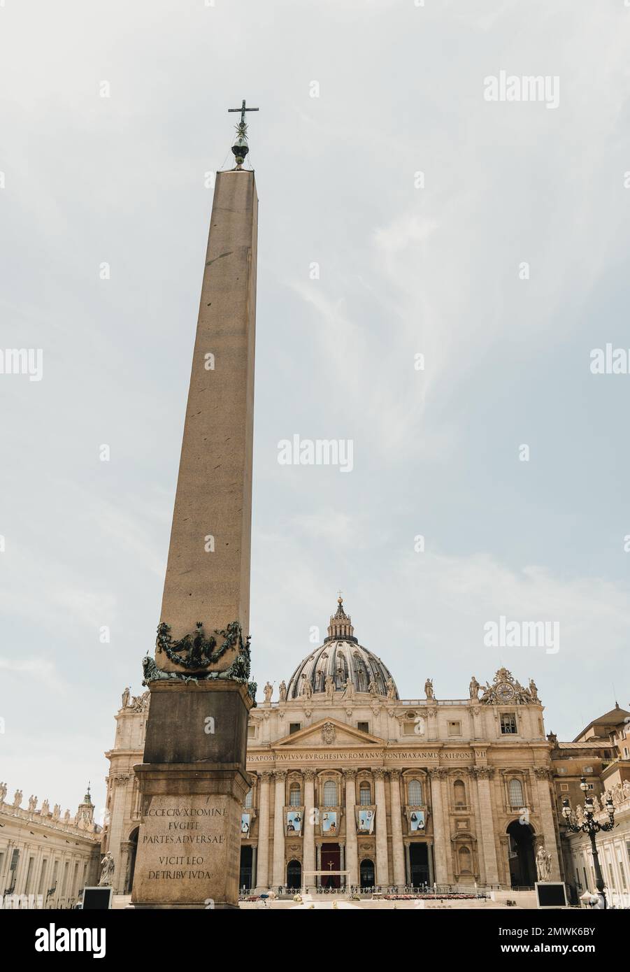 A vertical shot of the obelisk with a background of St. Peter's ...