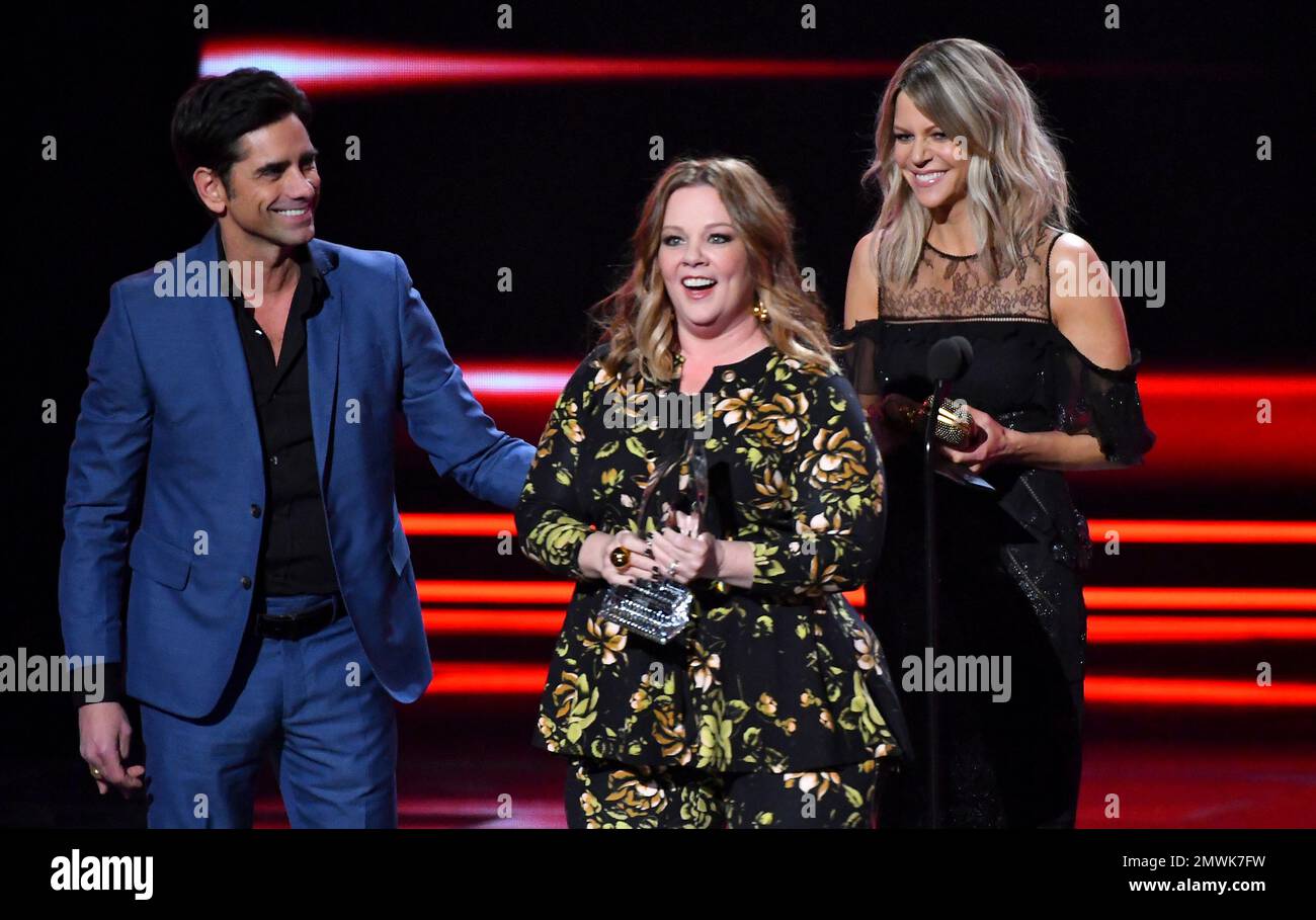 Melissa McCarthy, center, accepts the award for favorite comedic movie ...