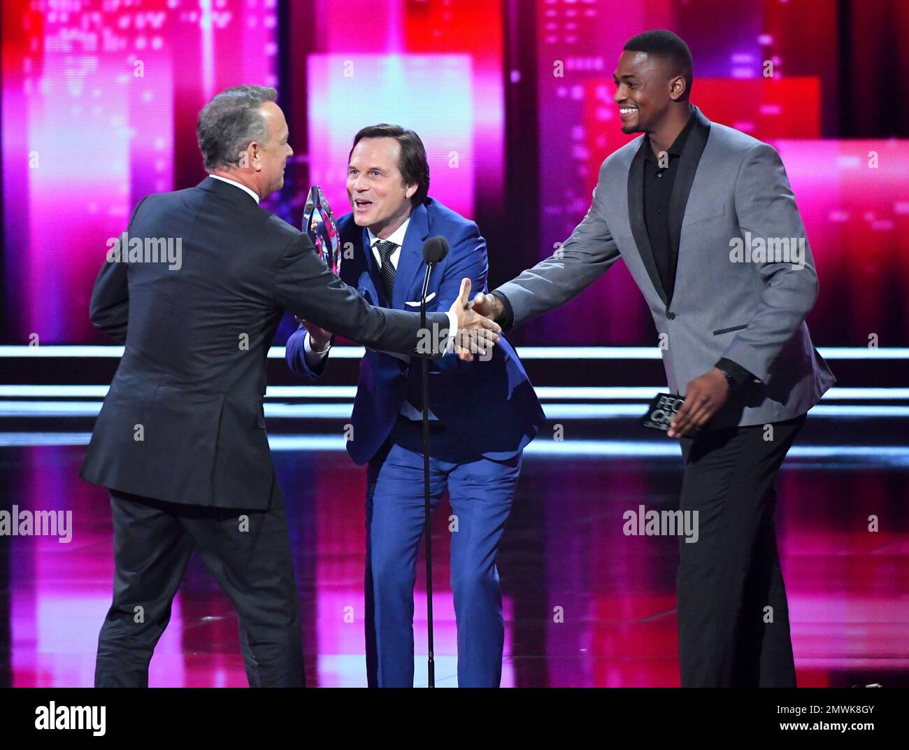 Tom Hanks, left, accepts the award for favorite dramatic movie actor ...