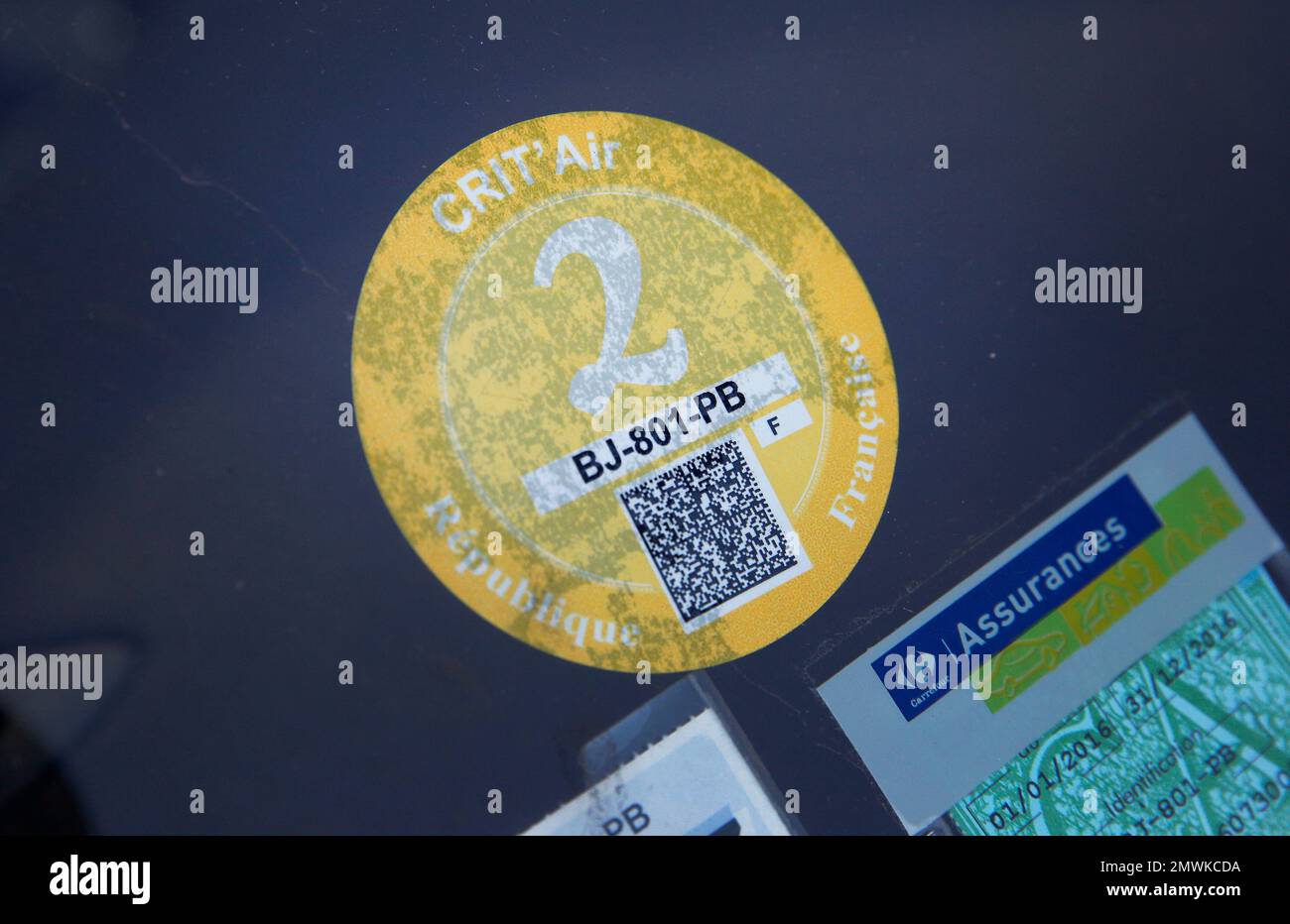 A "Crit'Air" (air criteria) sticker is pictured on a windscreen in ...