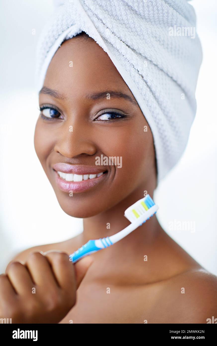 Keeping her smile beautiful. a beautiful young woman during her daily ...