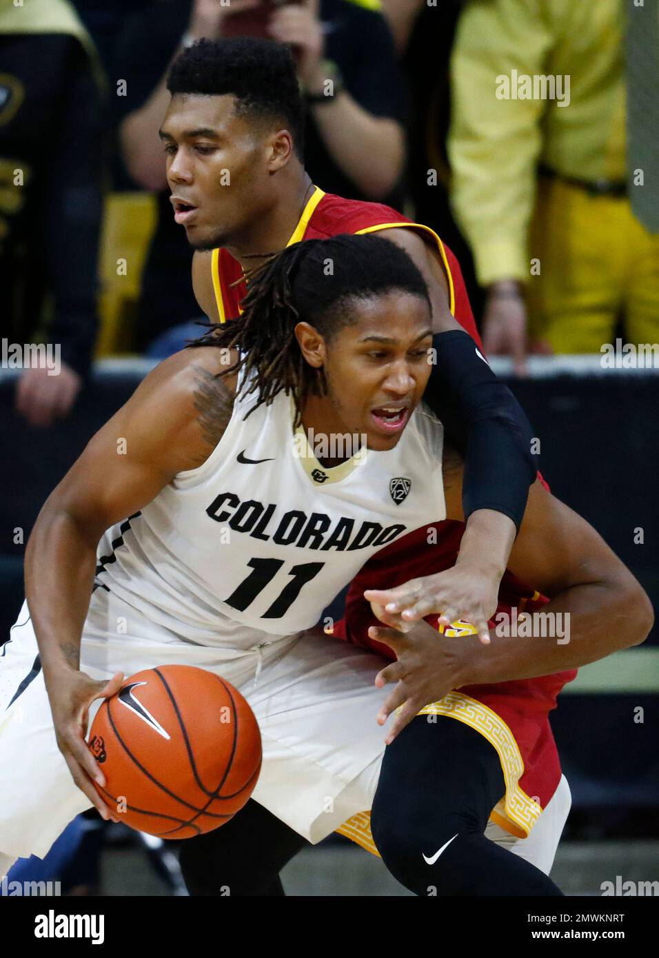 Colorado guard Xavier Johnson, front, drives past USC forward Charles ...