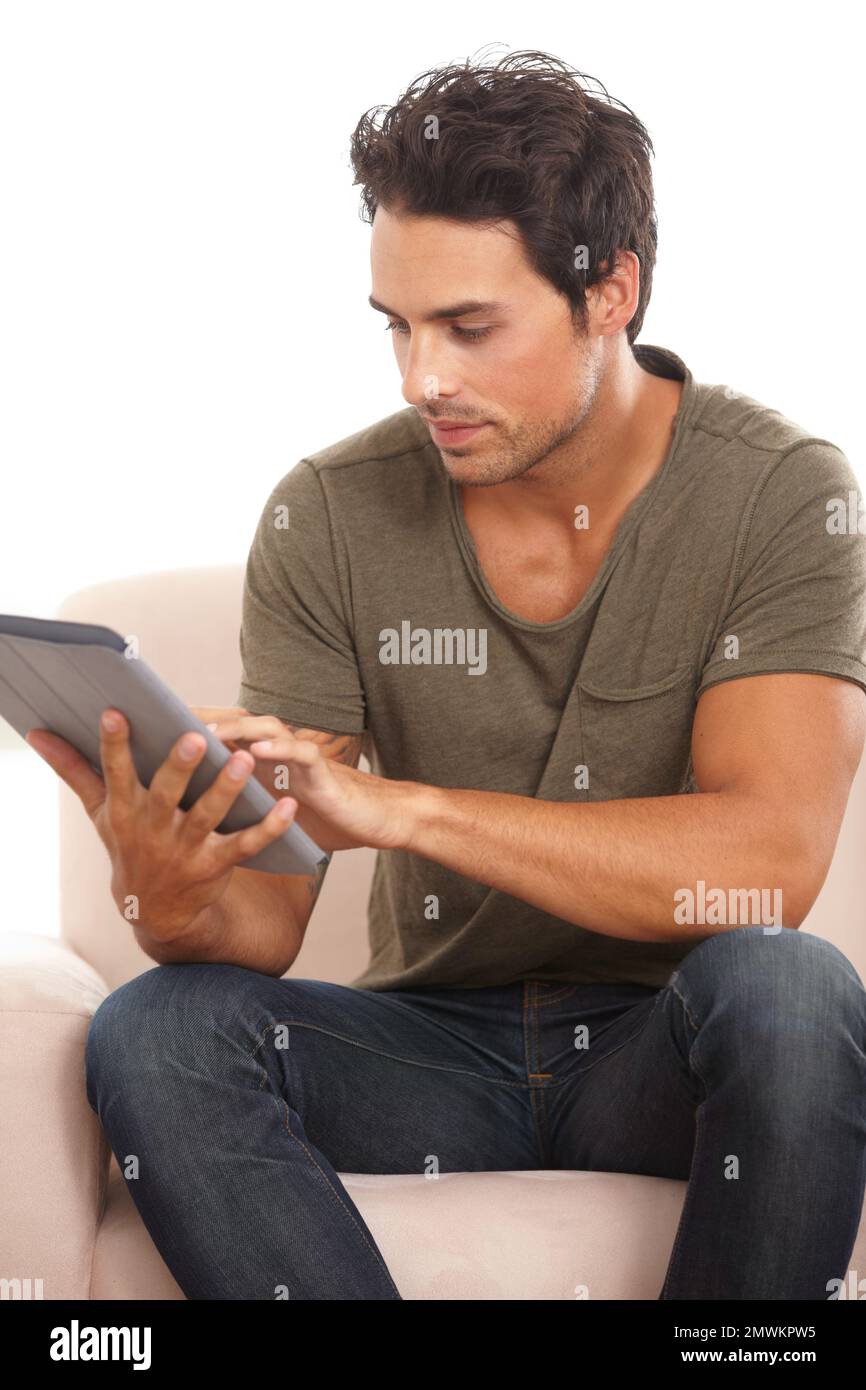 Going through his digital tablets new features. A handsome young man ...