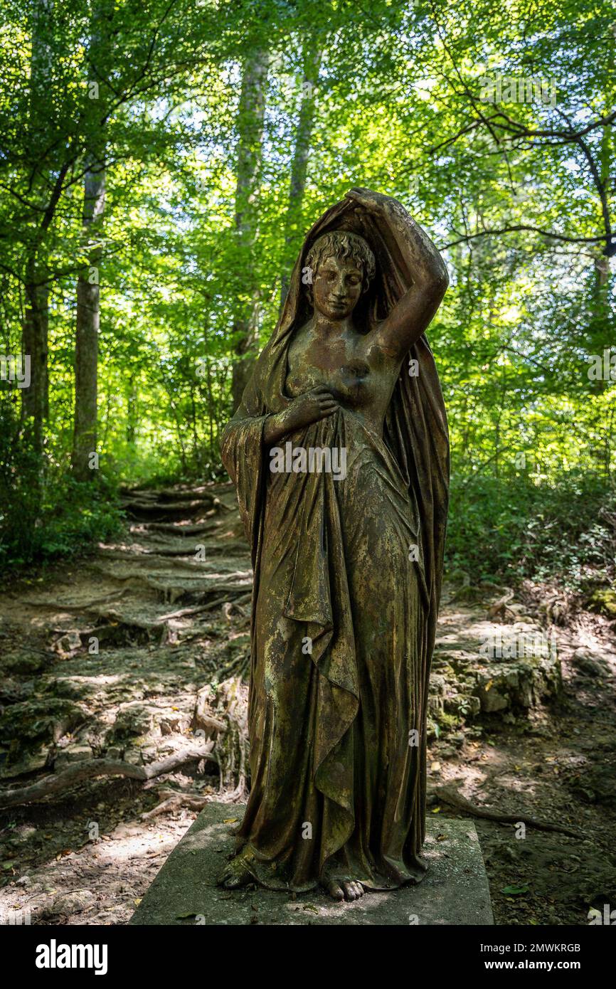 A vertical shot of the "Lady of the Fall" old bronze statue in ...