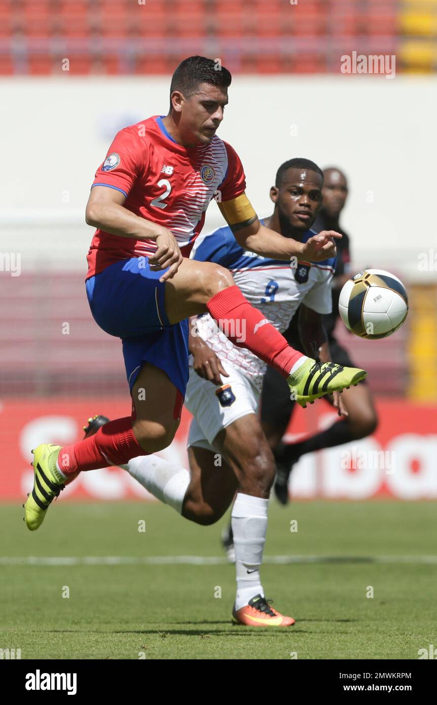 Costa Rica's Johnny Acosta controls the ball as Belize's Deon Mccaulay ...