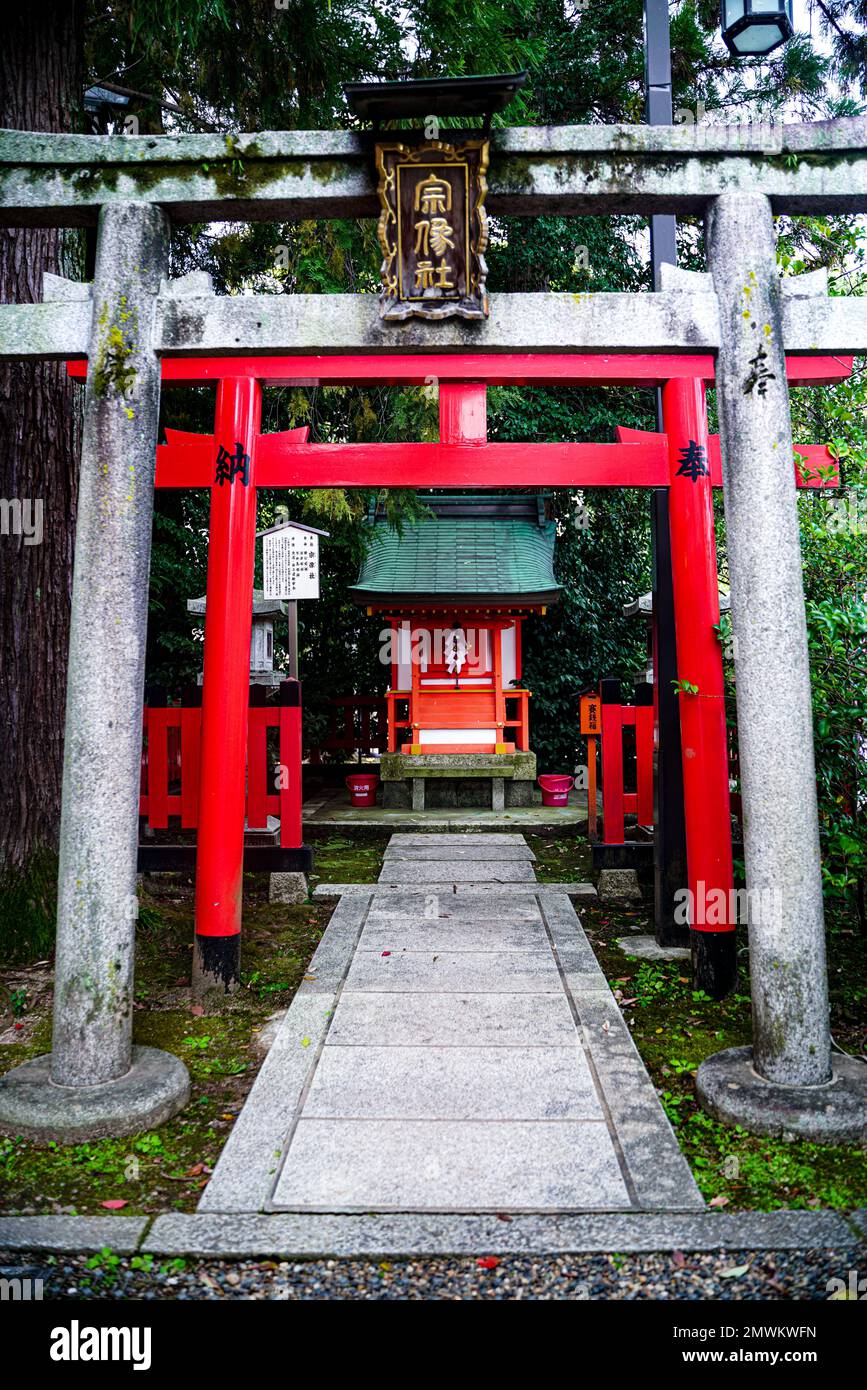 A vertical shot of torii traditional japanese gate at the entrance of a ...