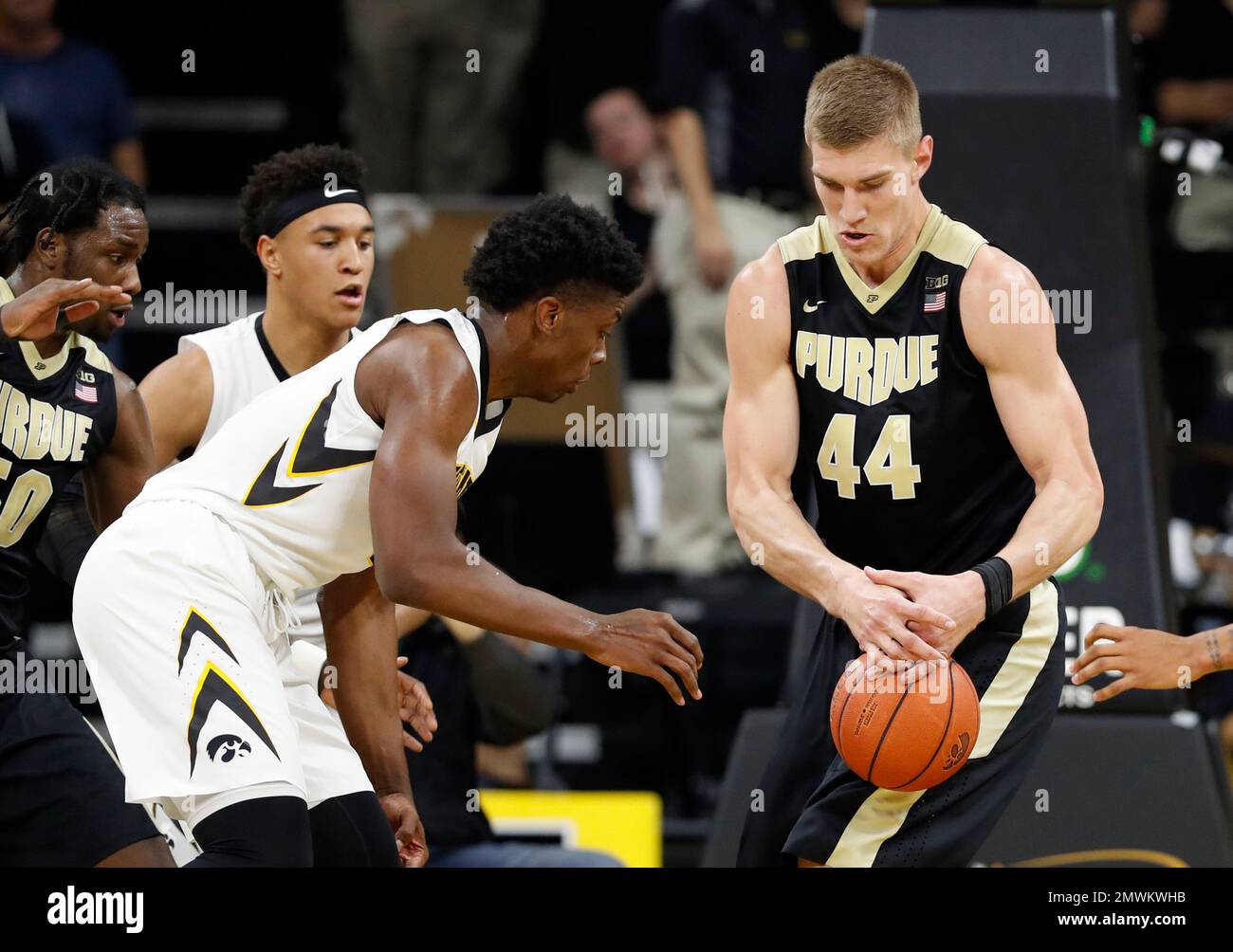 Purdue center Isaac Haas (44) fights for a loose ball with Iowa forward ...