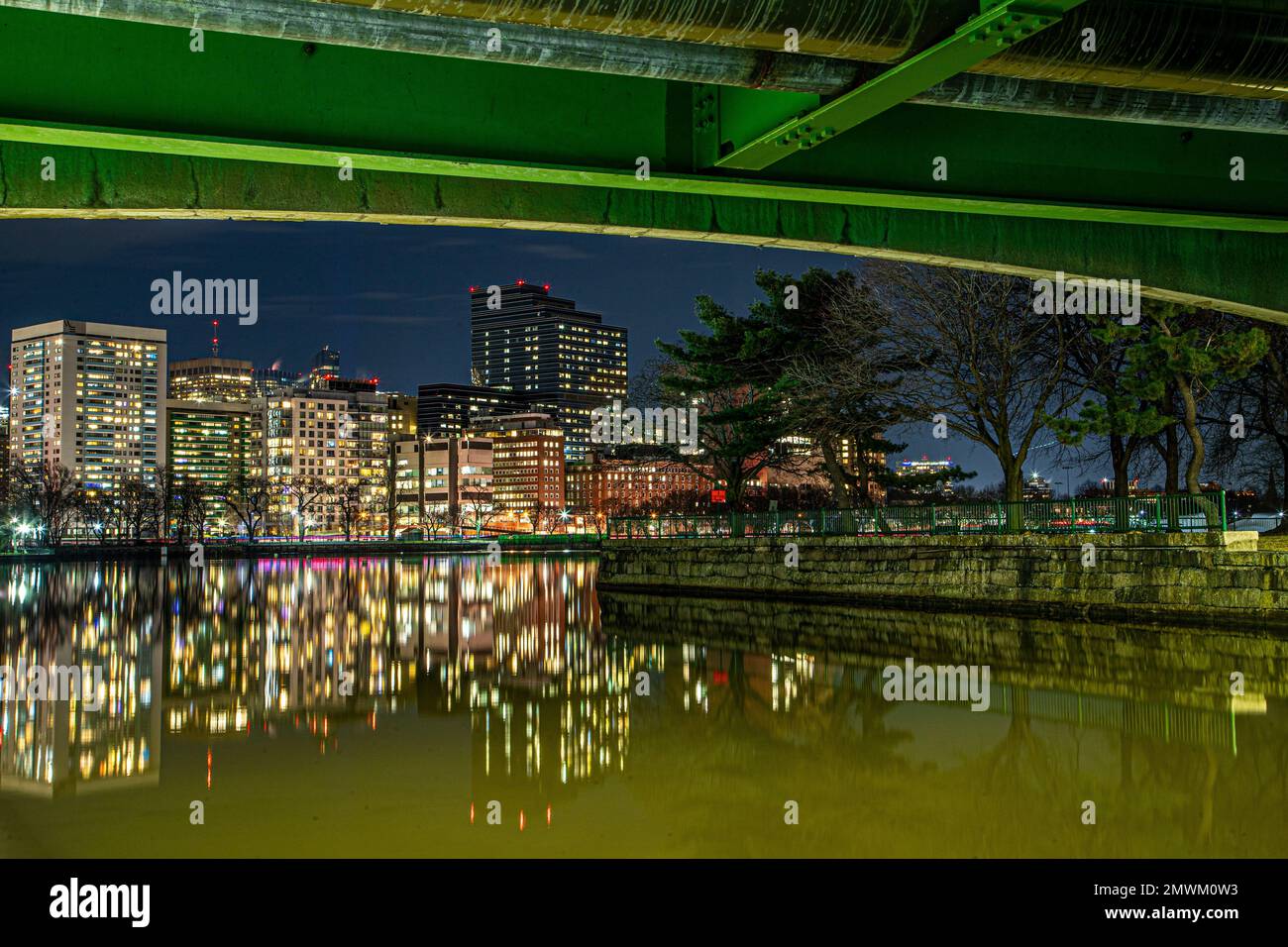 The cityscape and the reflection of the buildings with lights on a ...