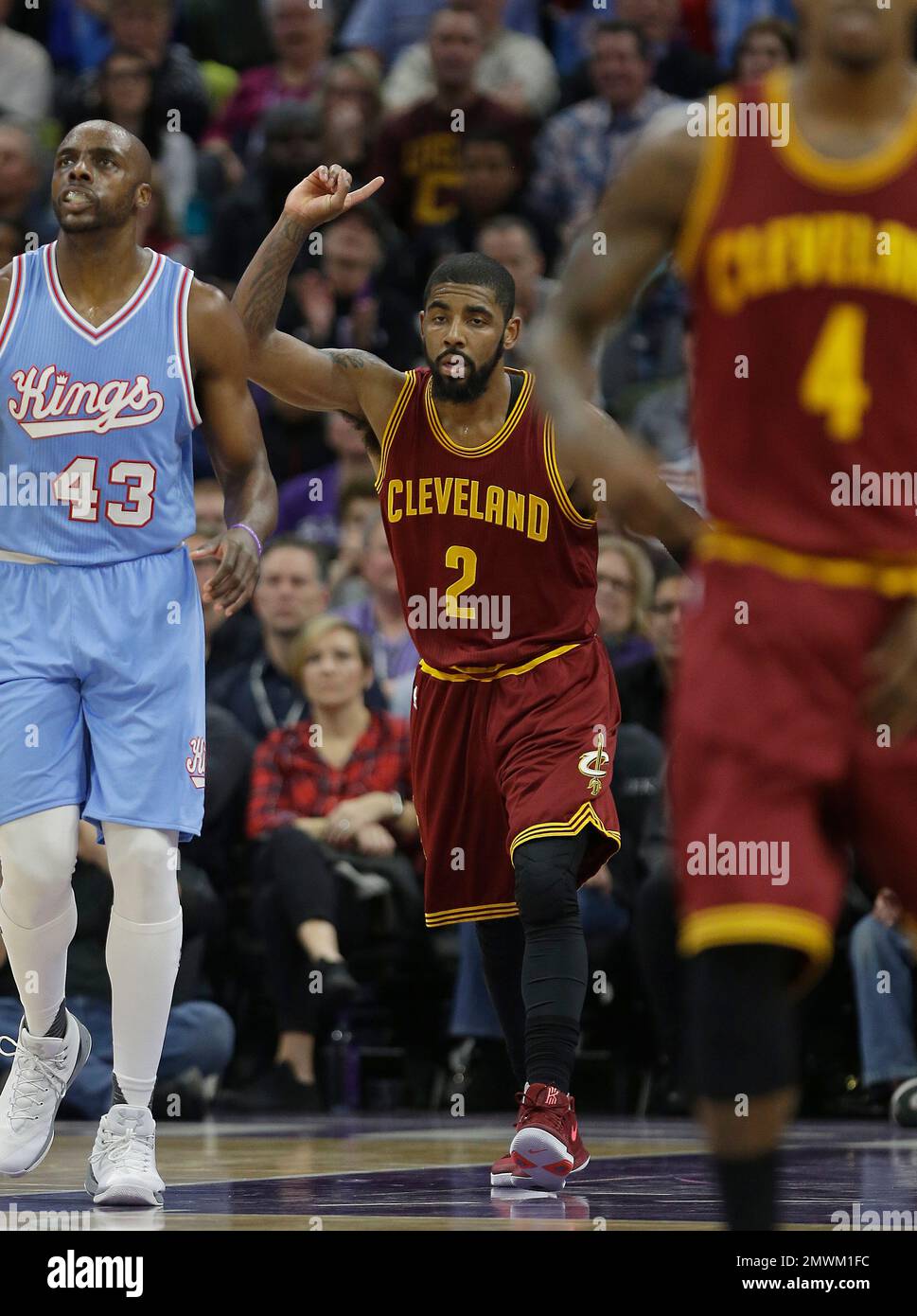 Cleveland Cavaliers guard Kyrie Irving, center, flashes one finger ...
