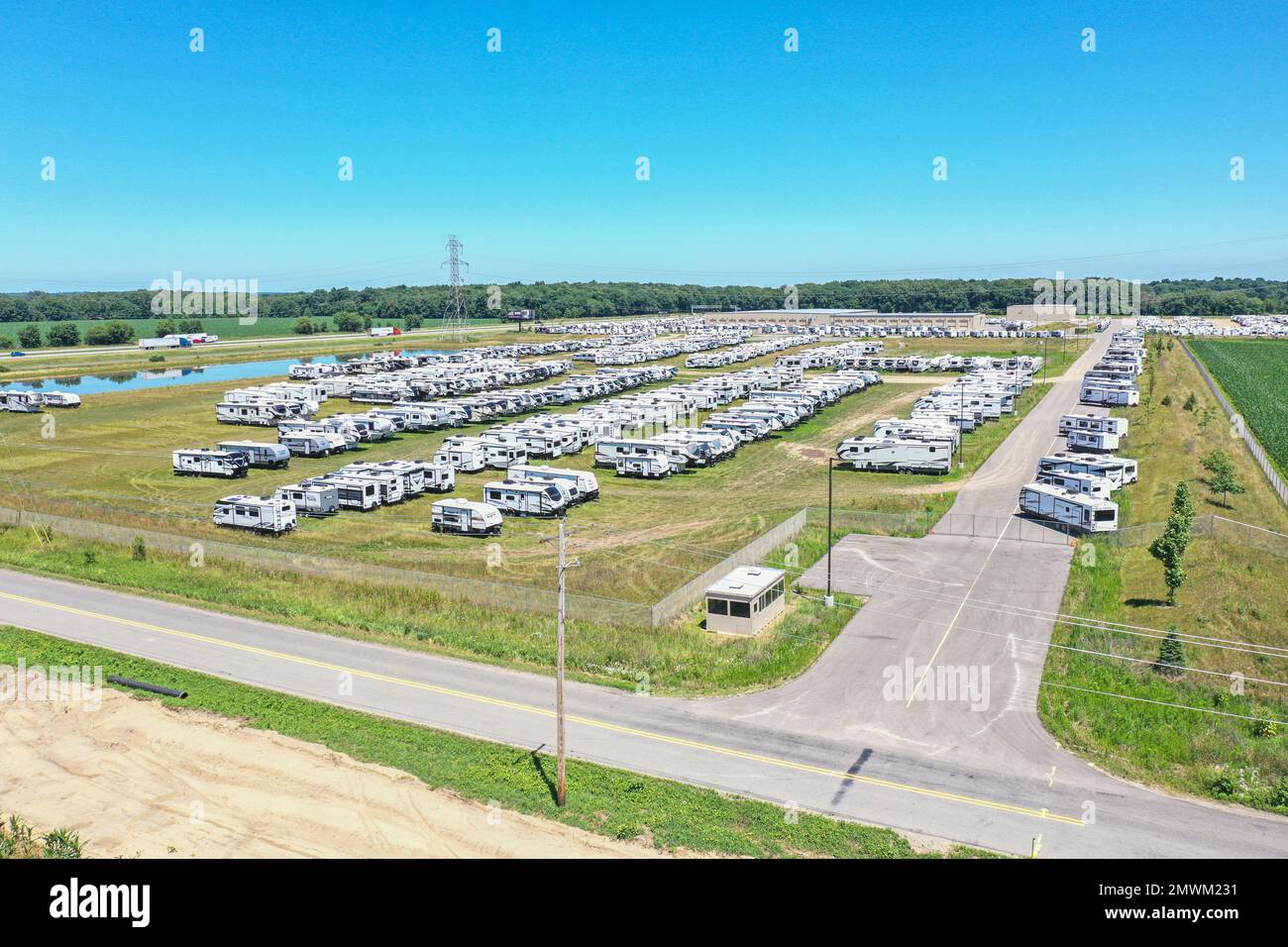 An aerial view of a green field with many parked trailers Stock Photo ...